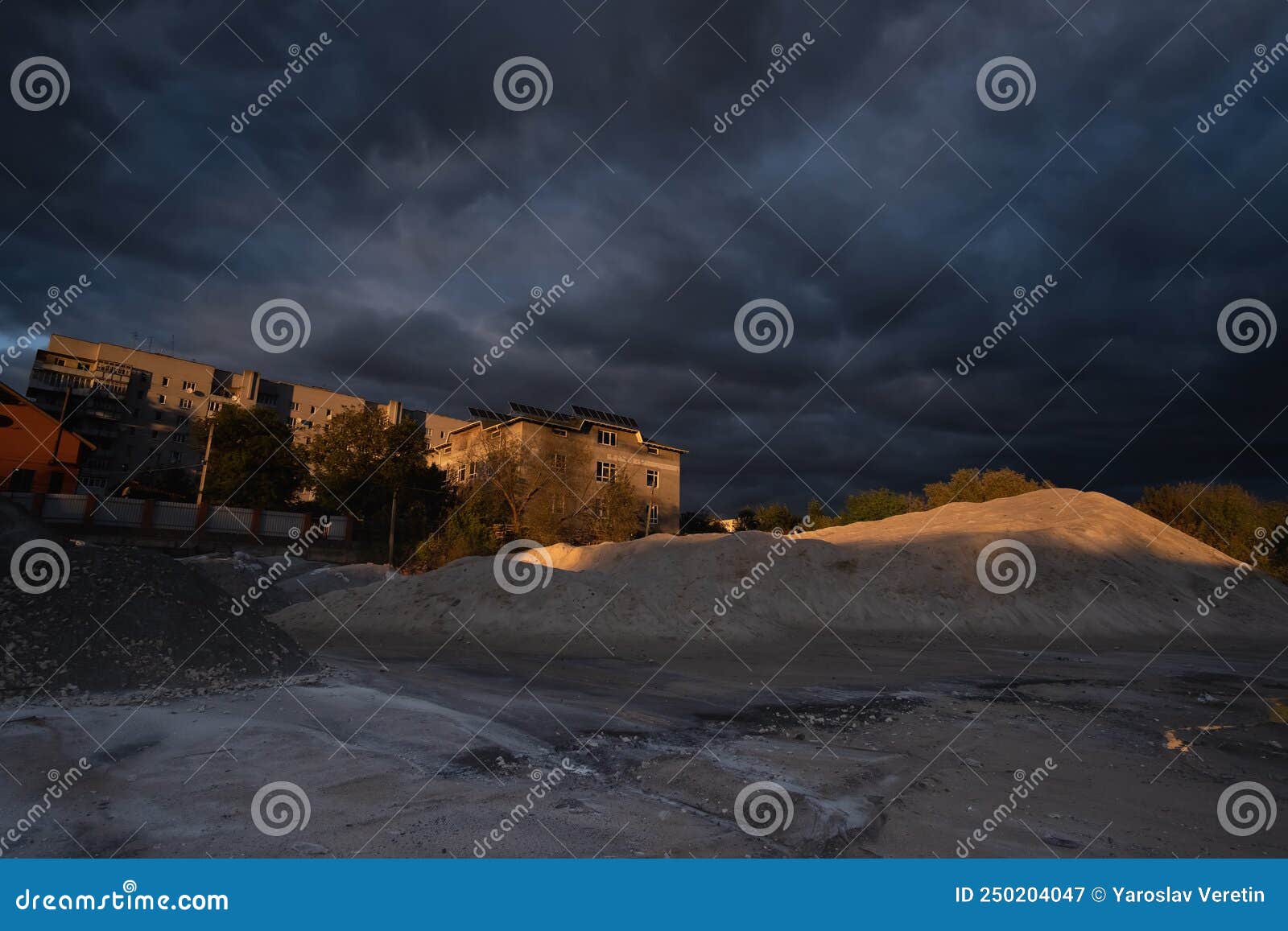Dramatic Storm Clouds Over the Rooftops at Summer Sunset Stock Image ...