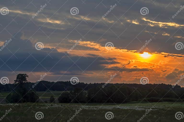 Dramatic Summer Sunset Over Fields and Forests. Stock Image - Image of ...