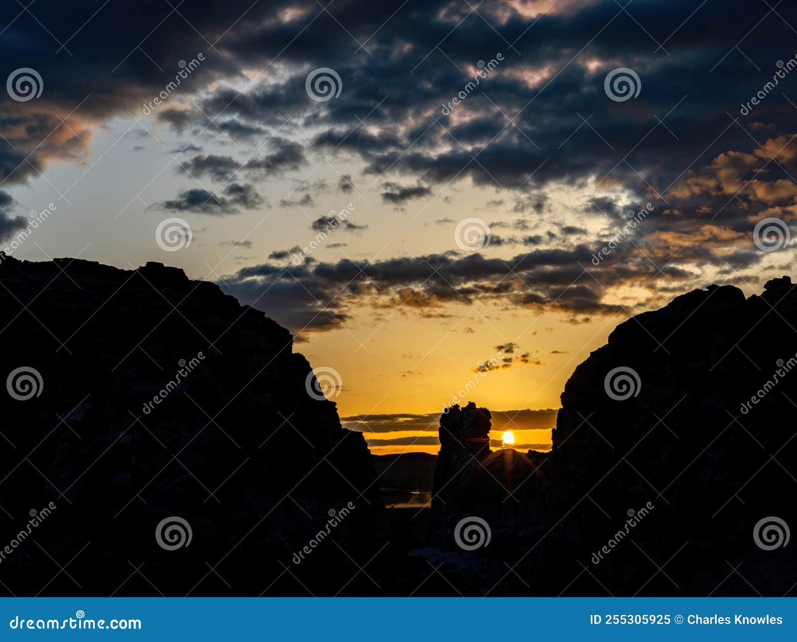 Dramatic Sunrise Seen through a Window of Rock Stock Image - Image of ...