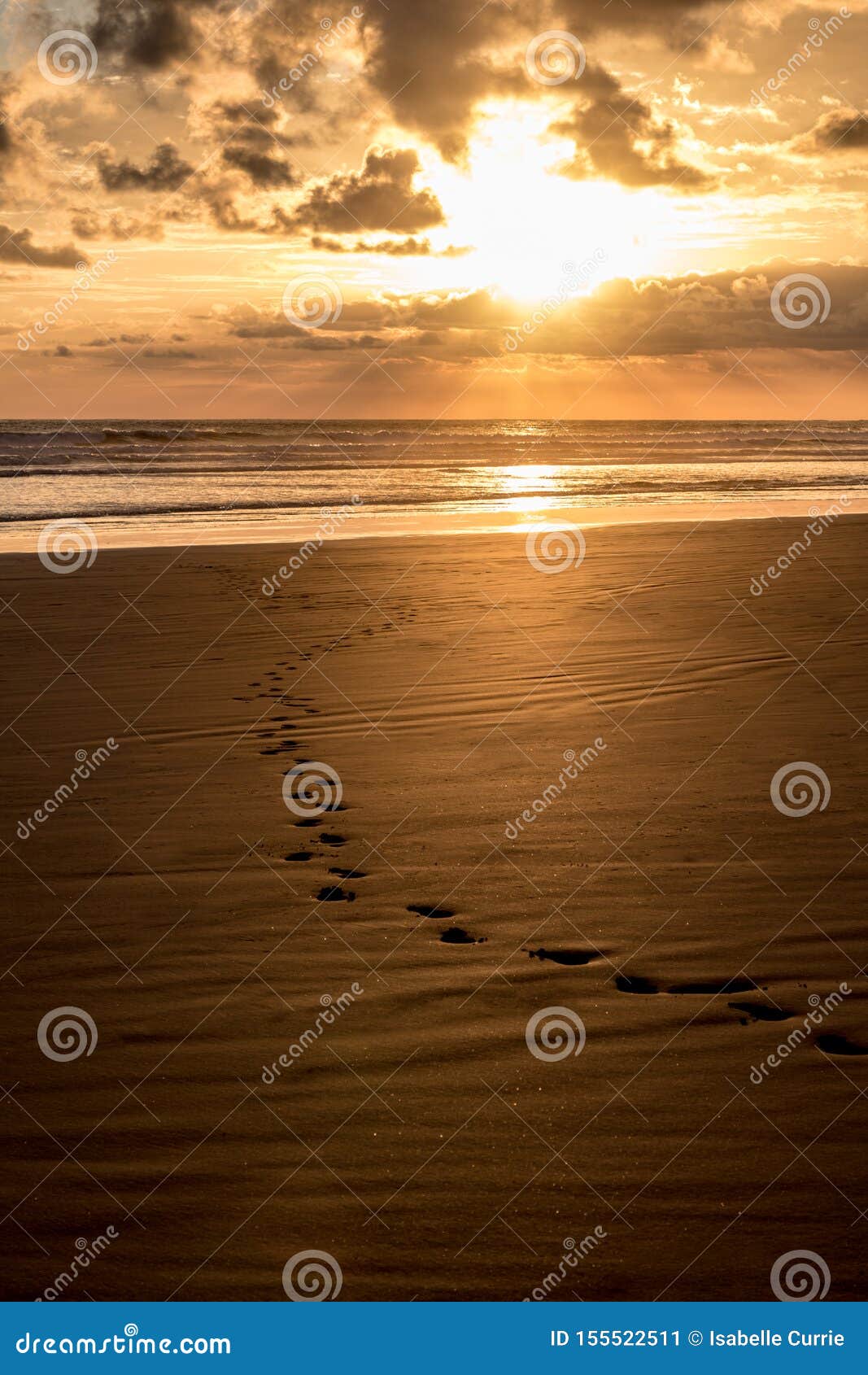 Dramatic Sunset with Footsteps on a Sandy Beach Stock Image - Image of ...