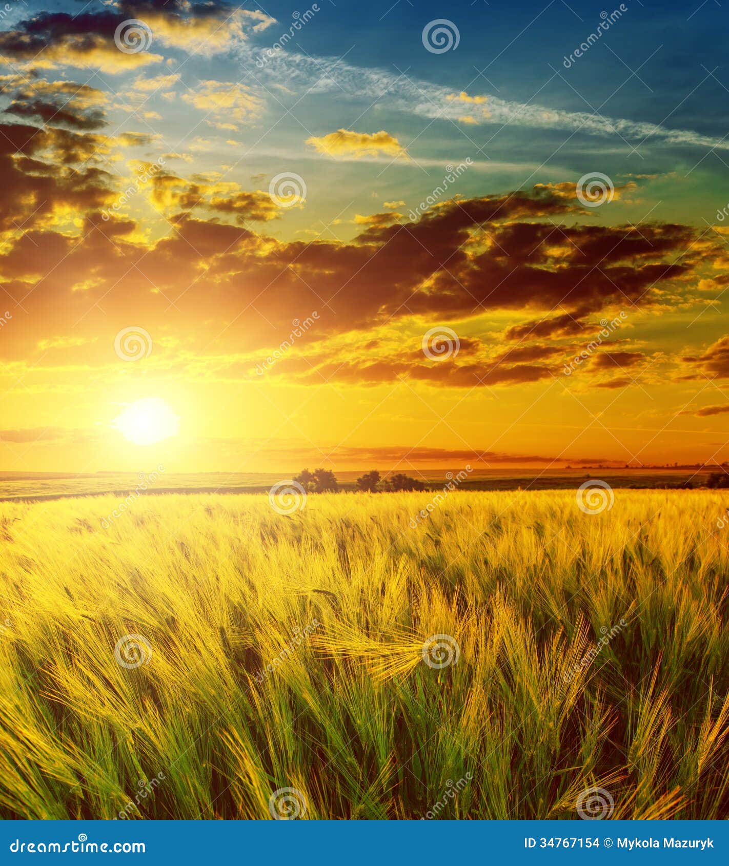 Dramatic sunset over field stock photo. Image of blue - 34767154