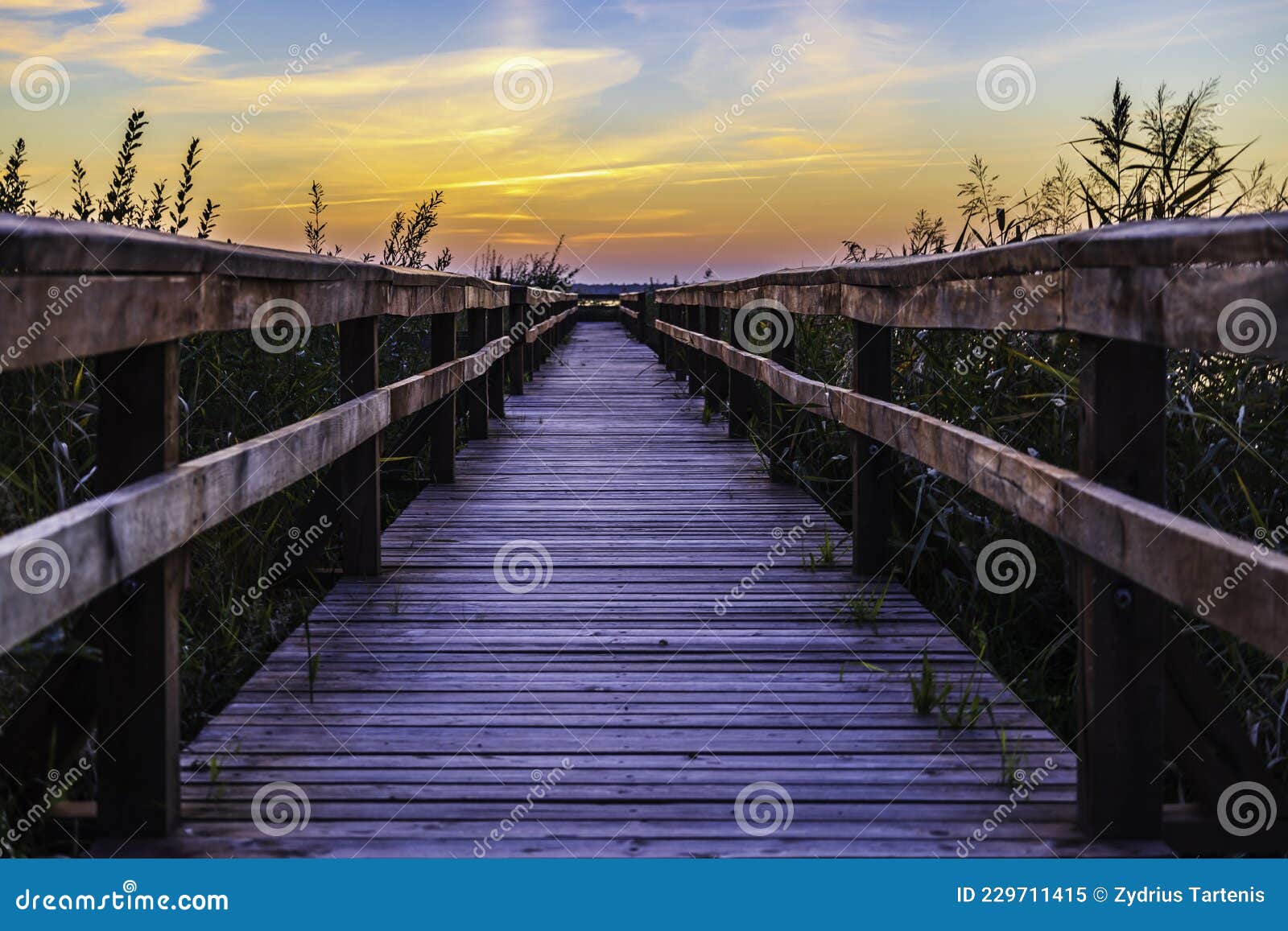 Dramatic Sunset Over Lake and Wooden Walkway with Railing Stock Image ...