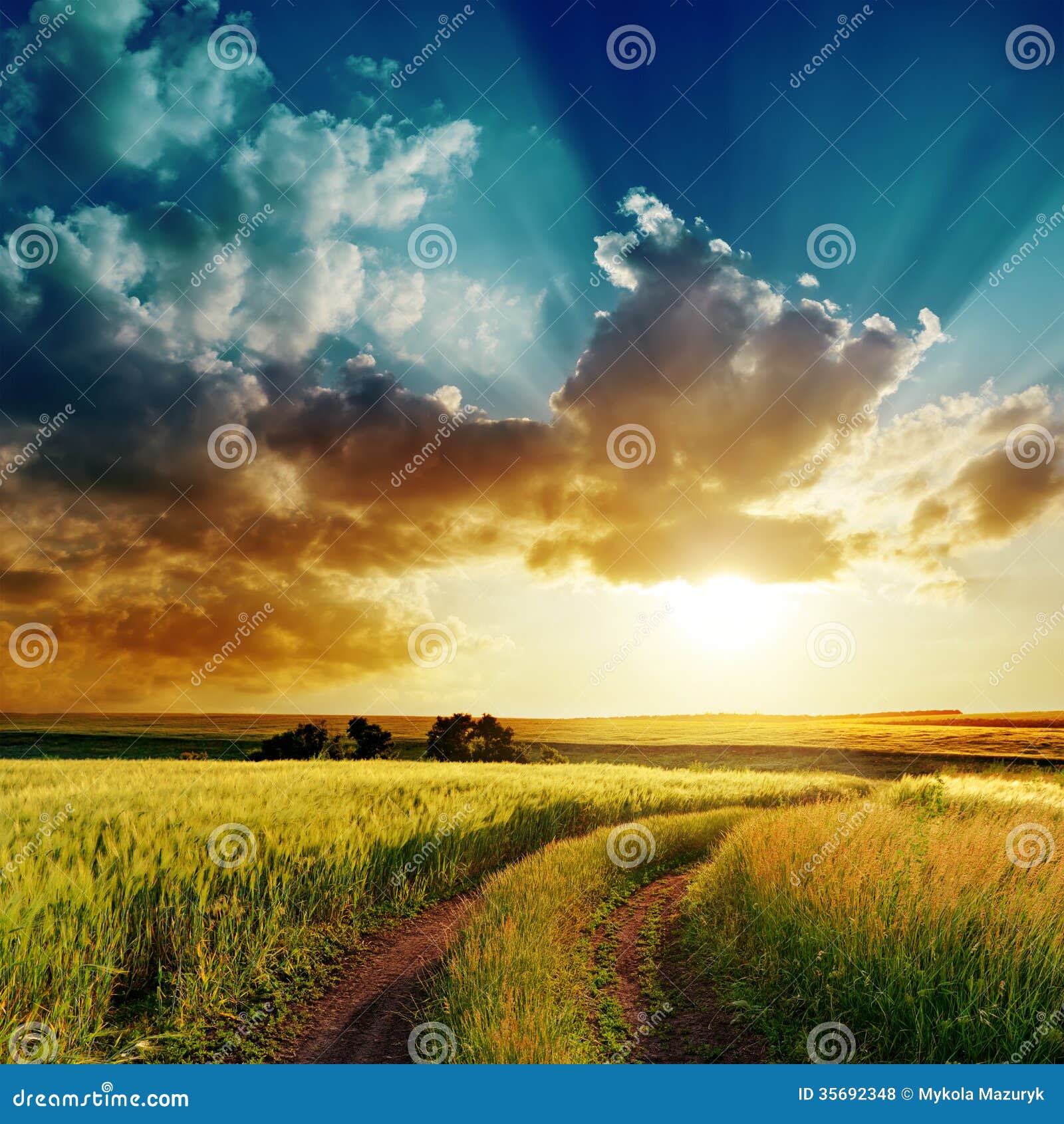 Dramatic Sunset Over Road in Green Field Stock Photo - Image of cloud ...