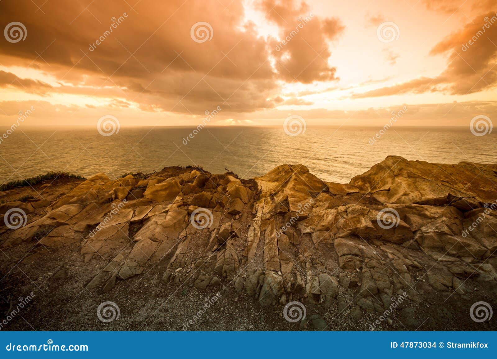 Dramatic Sunset Rays through a Cloudy Dark Sky Over the Ocean Stock ...
