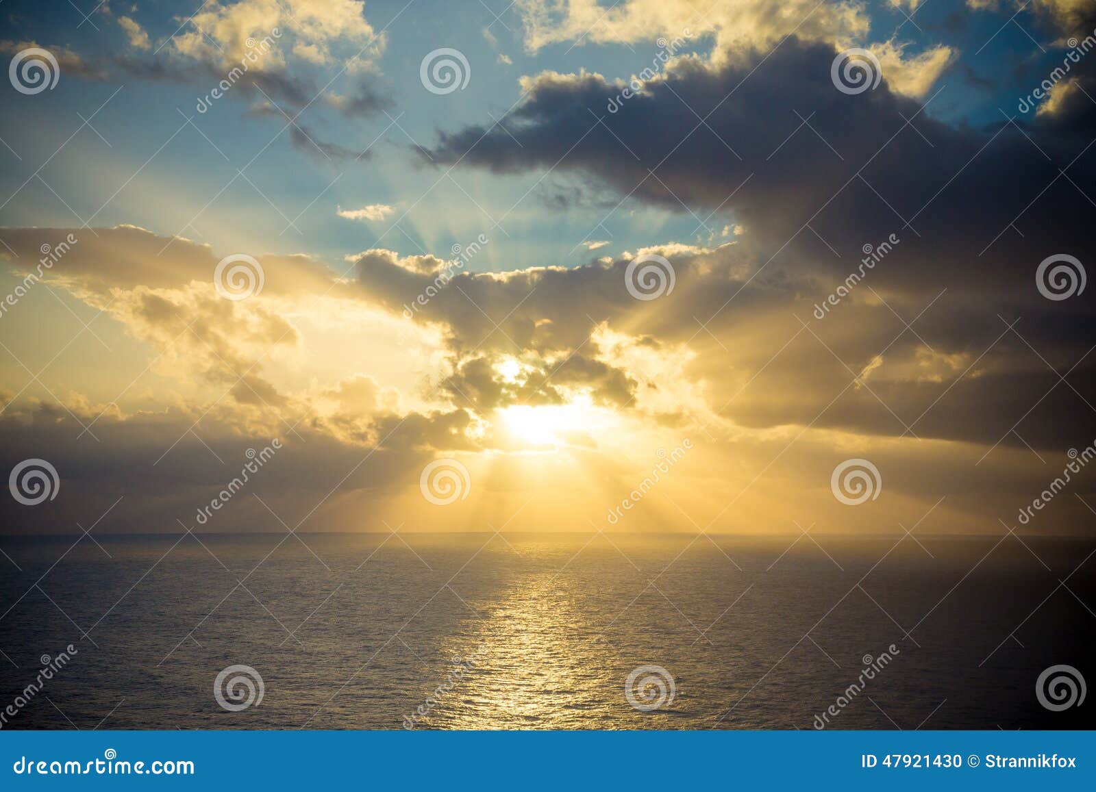 Dramatic Sunset Rays through a Cloudy Dark Sky Over the Ocean Stock ...