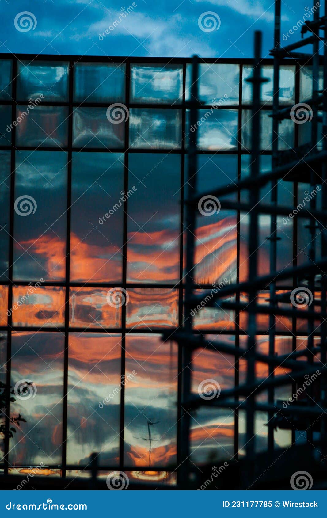 Dramatic Sunset Reflected on the Glass Facade of a Modern Building ...