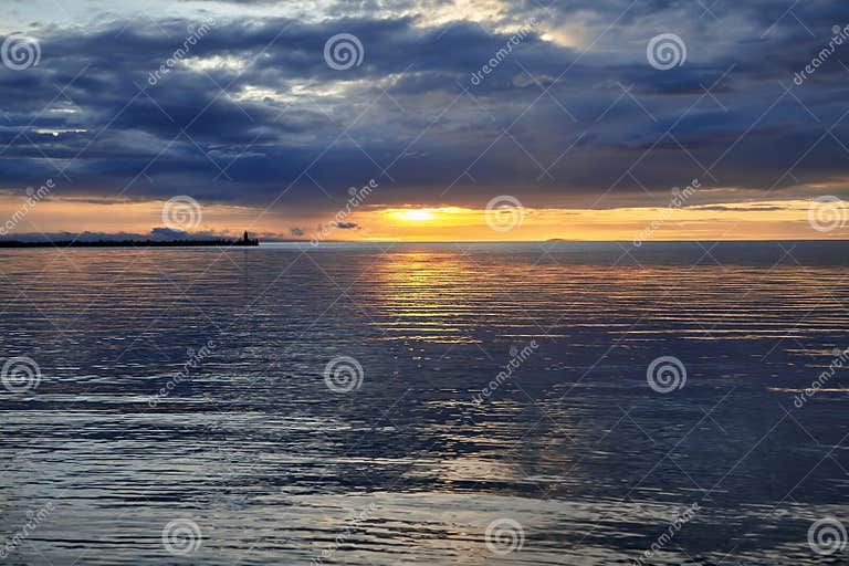 Dramatic Sunset with Thunderclouds before the Storm. Sea Pier with a Lighthouse Against the ...