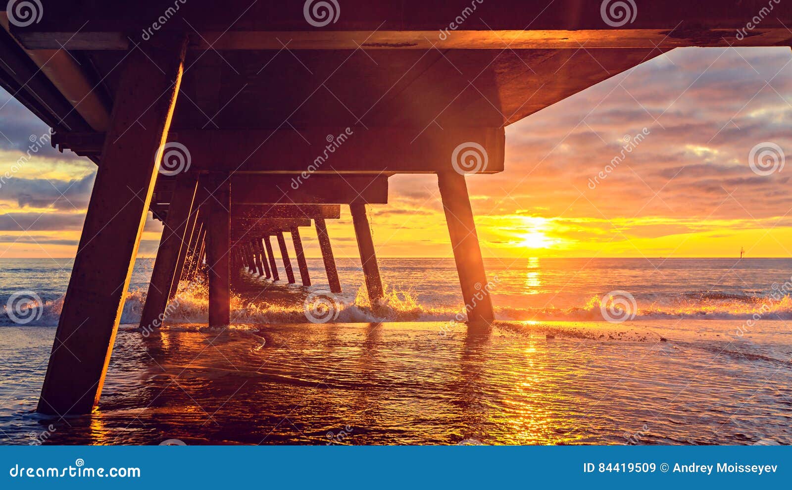 Dramatic Sunset View from Under Pier Stock Image - Image of beach ...