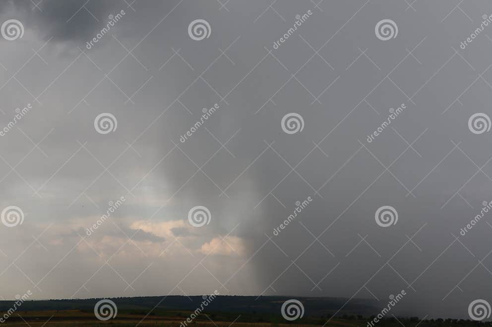 A Dramatic Thunderstorm with Dark Clouds and Heavy Rainfall Creates a ...