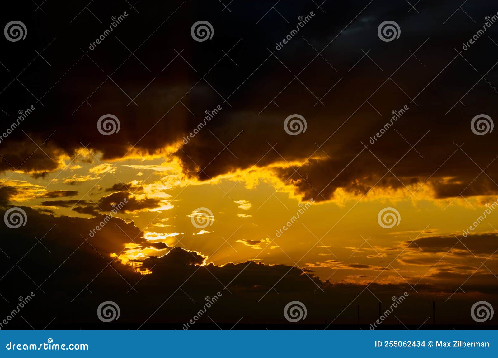 Dramatic Yellow and Orange Sunset Sky with Clouds and Sun Rays Stock ...
