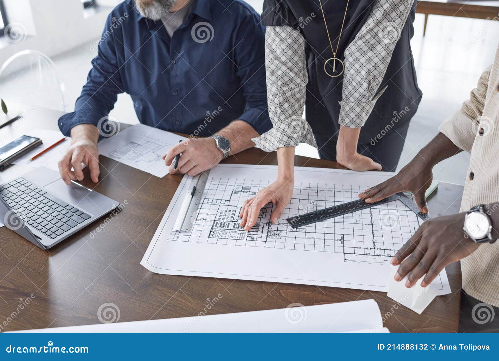Drawing blueprints in team stock photo. Image of sitting - 214888132