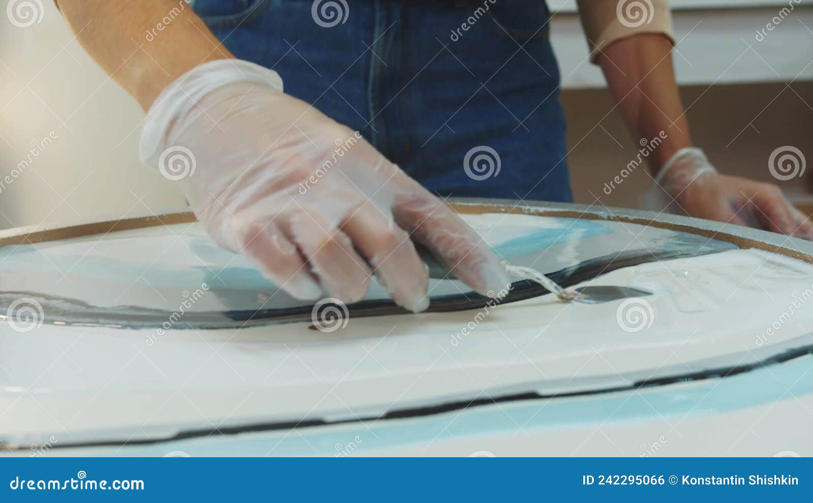 Drawing a Design on the Round Epoxy Resin Art Object Using a Spatula ...