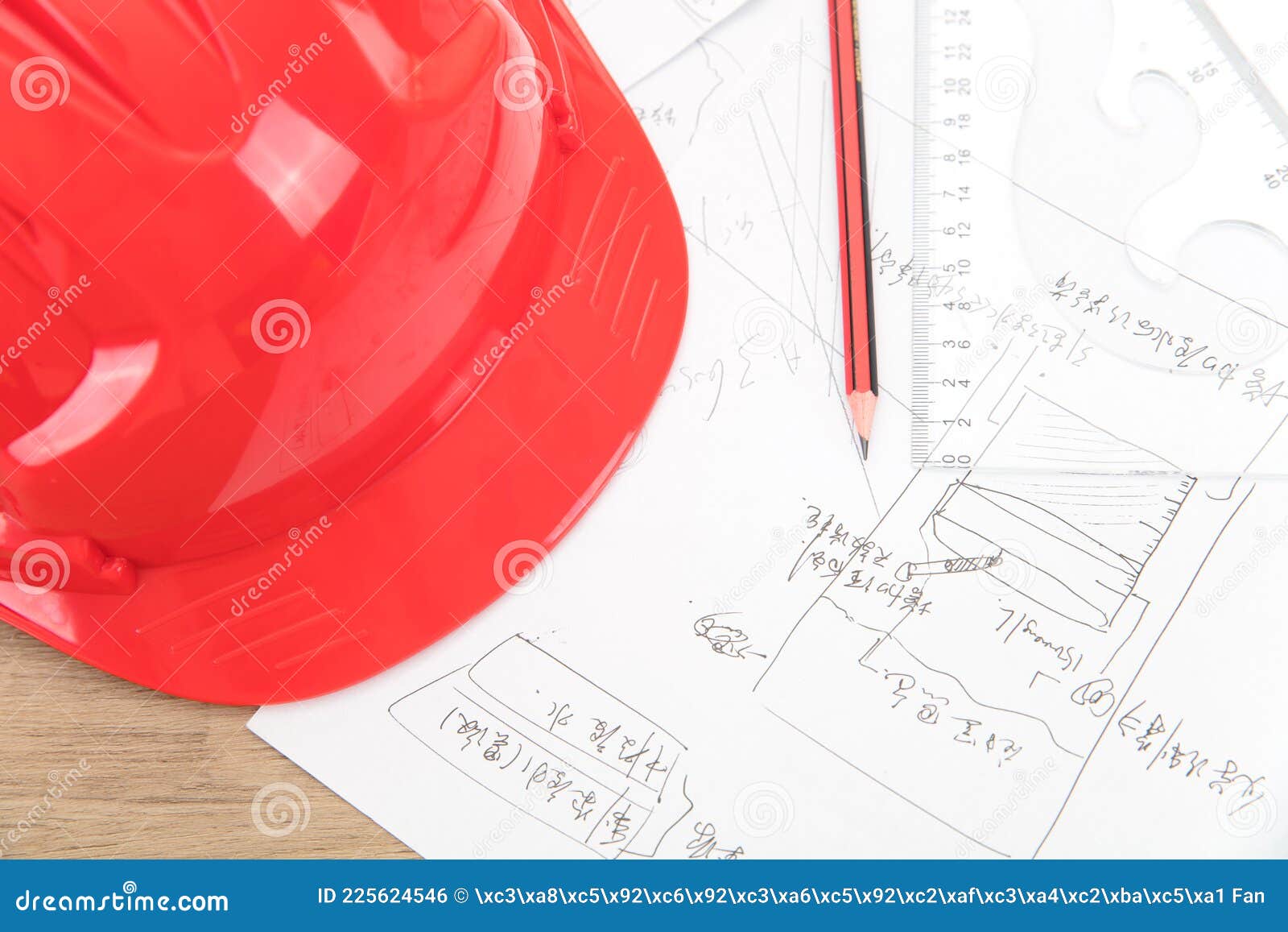 Drawings and Pencils and a Red Hard Hat on the Table Stock Photo ...