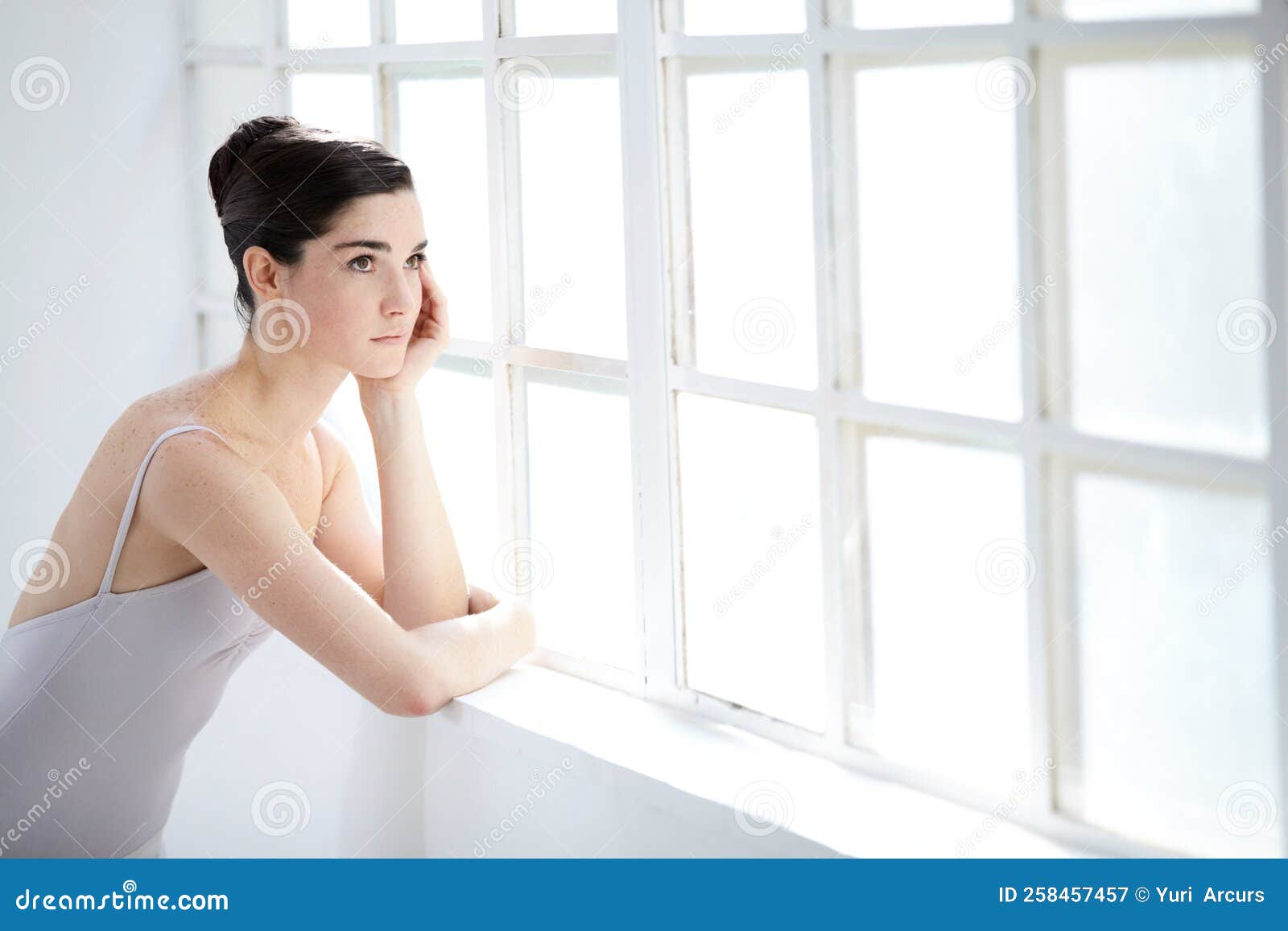 Dreaming of Dancing the Lead. Thoughtful Young Ballerina Looking Out of a Window. Stock Image ...