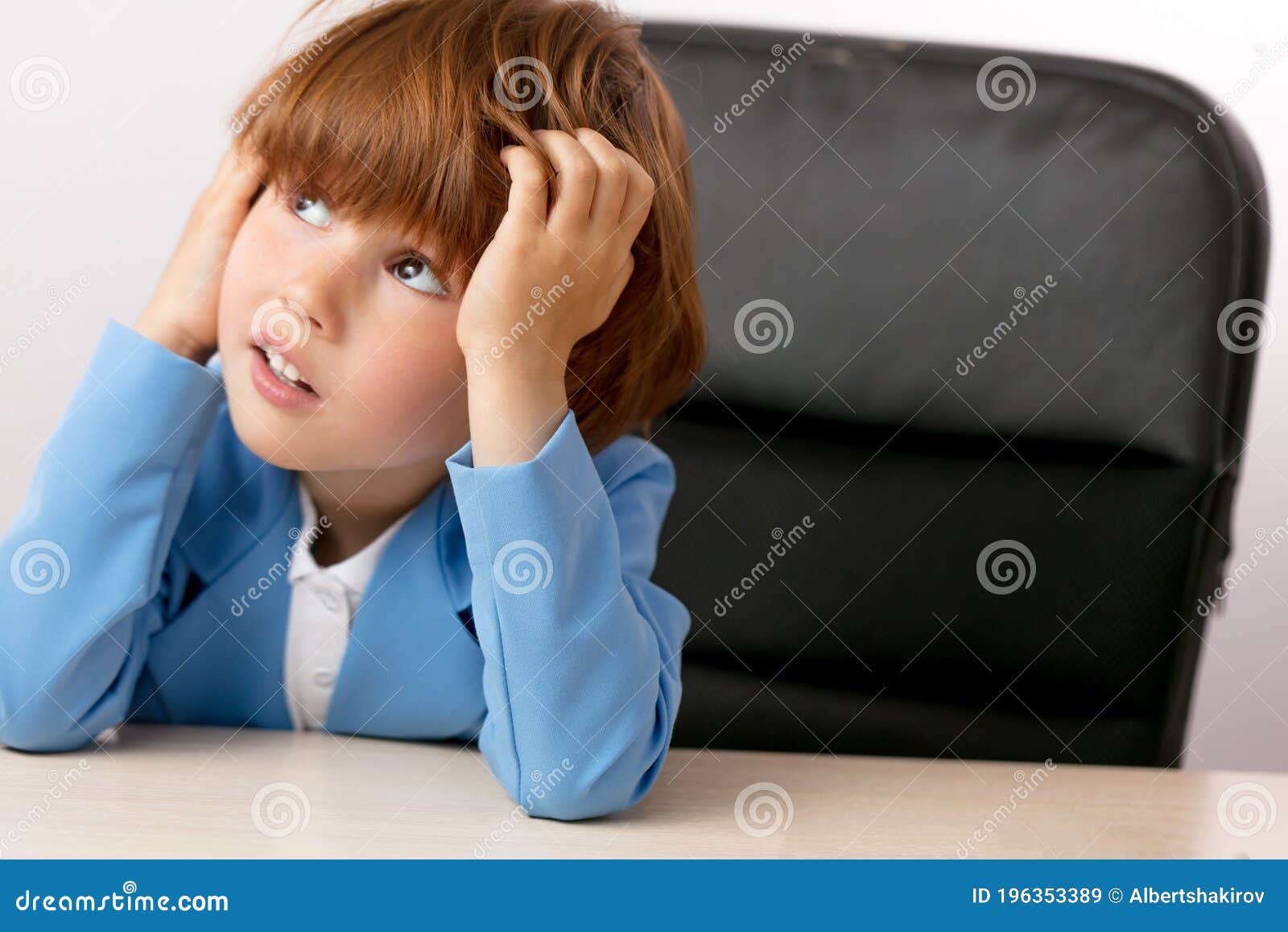 A Dreaming Ginger Boy is Holding His Head and Thinking about Something ...