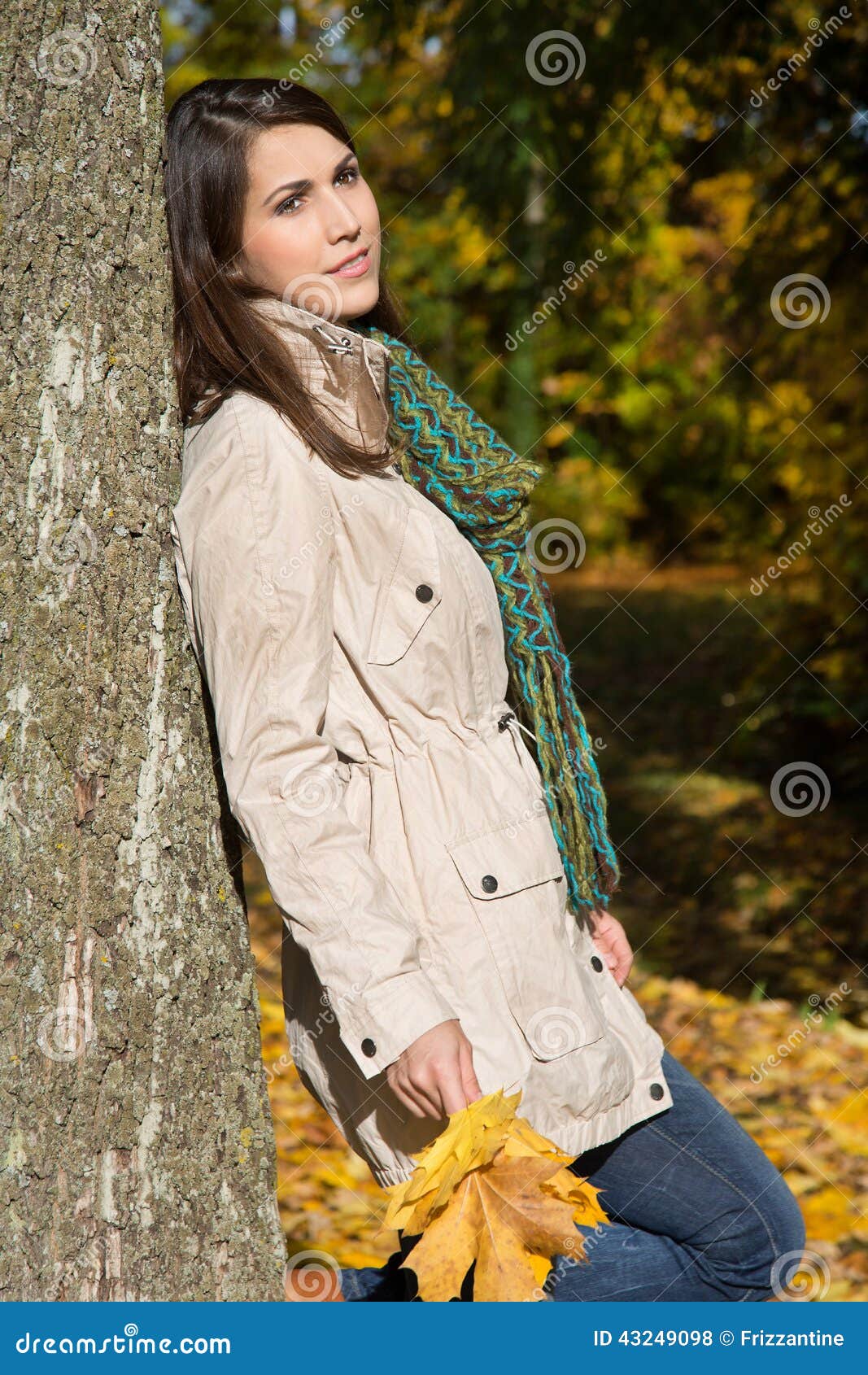 Dreaming Young Woman Leaning on a Tree Trunk in Fall. Stock Photo ...