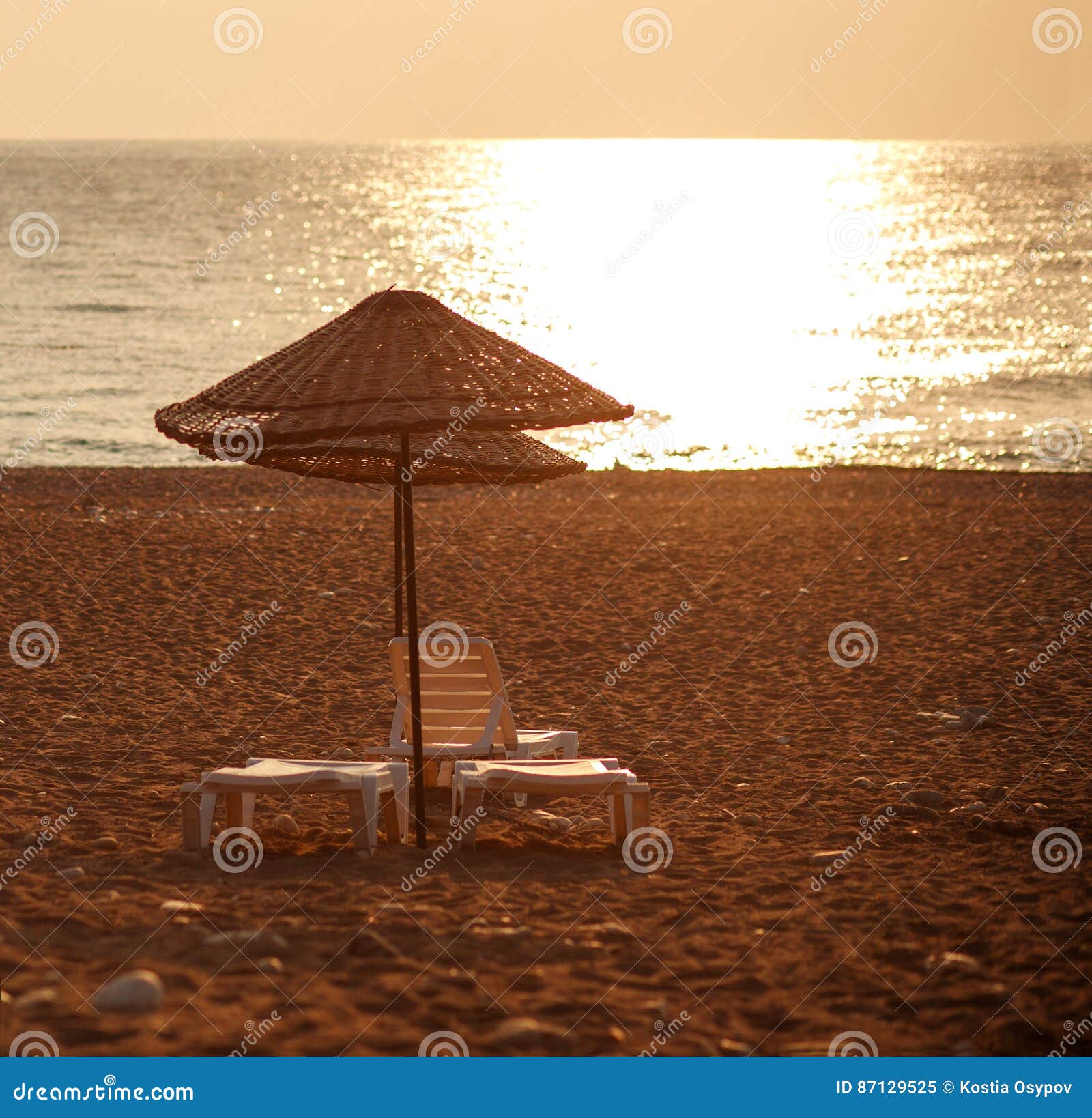 Dreamy Beach with Sun Loungers Under Parasol on Setting Sun Stock Image ...
