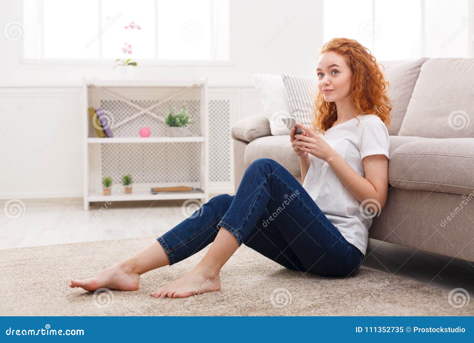 Young Redhead Girl Messaging On Smartphone On The Floor Stock Image Image Of Barefoot Redhead