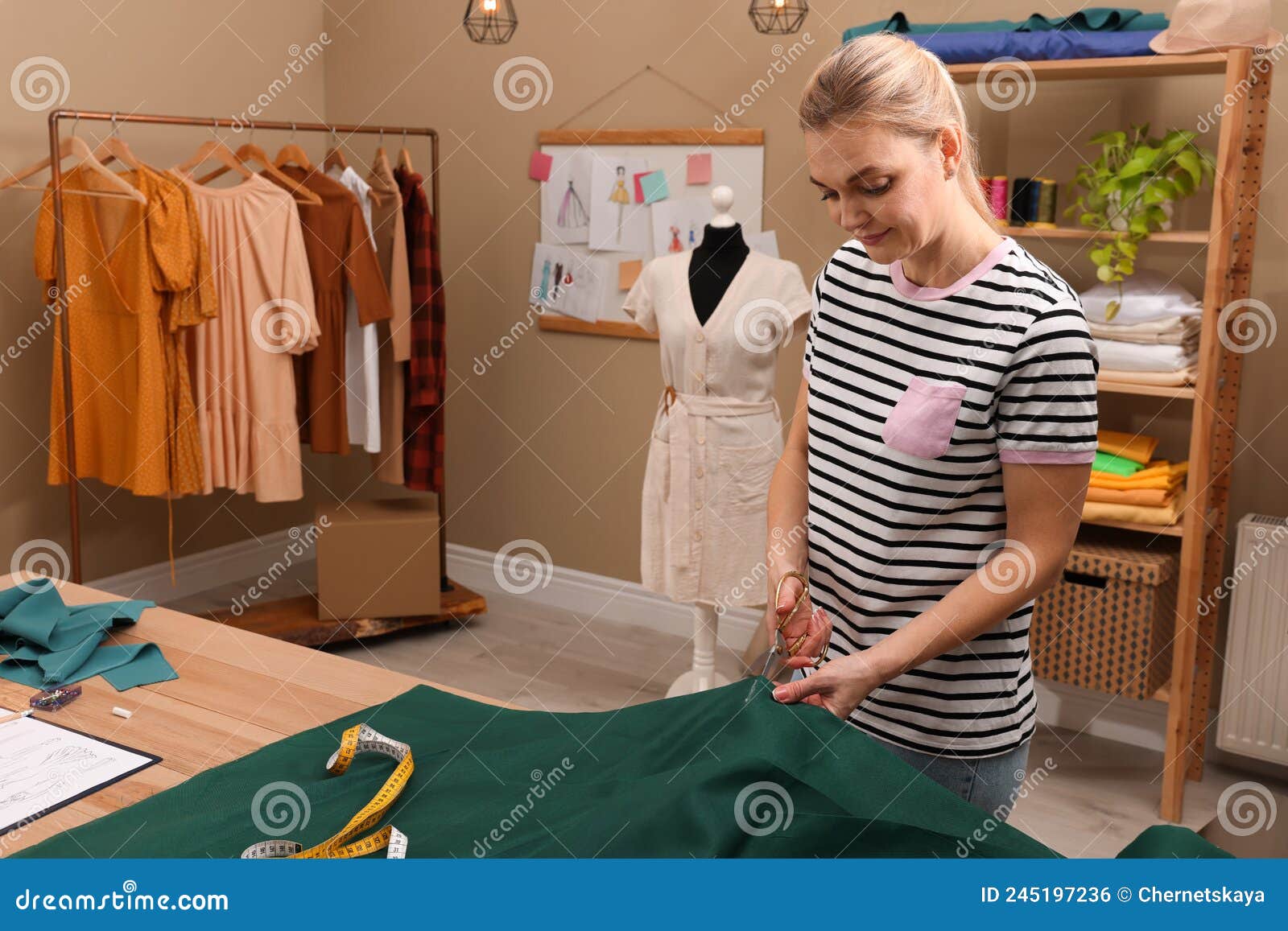Dressmaker Cutting Green Fabric at Table in Workshop Stock Photo ...