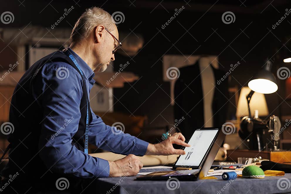 Dressmaker Looking at Sketches on Tablet Stock Image - Image of skilled ... Dressmaker Looking at Sketches on Tablet Stock Image - Image of skilled ...