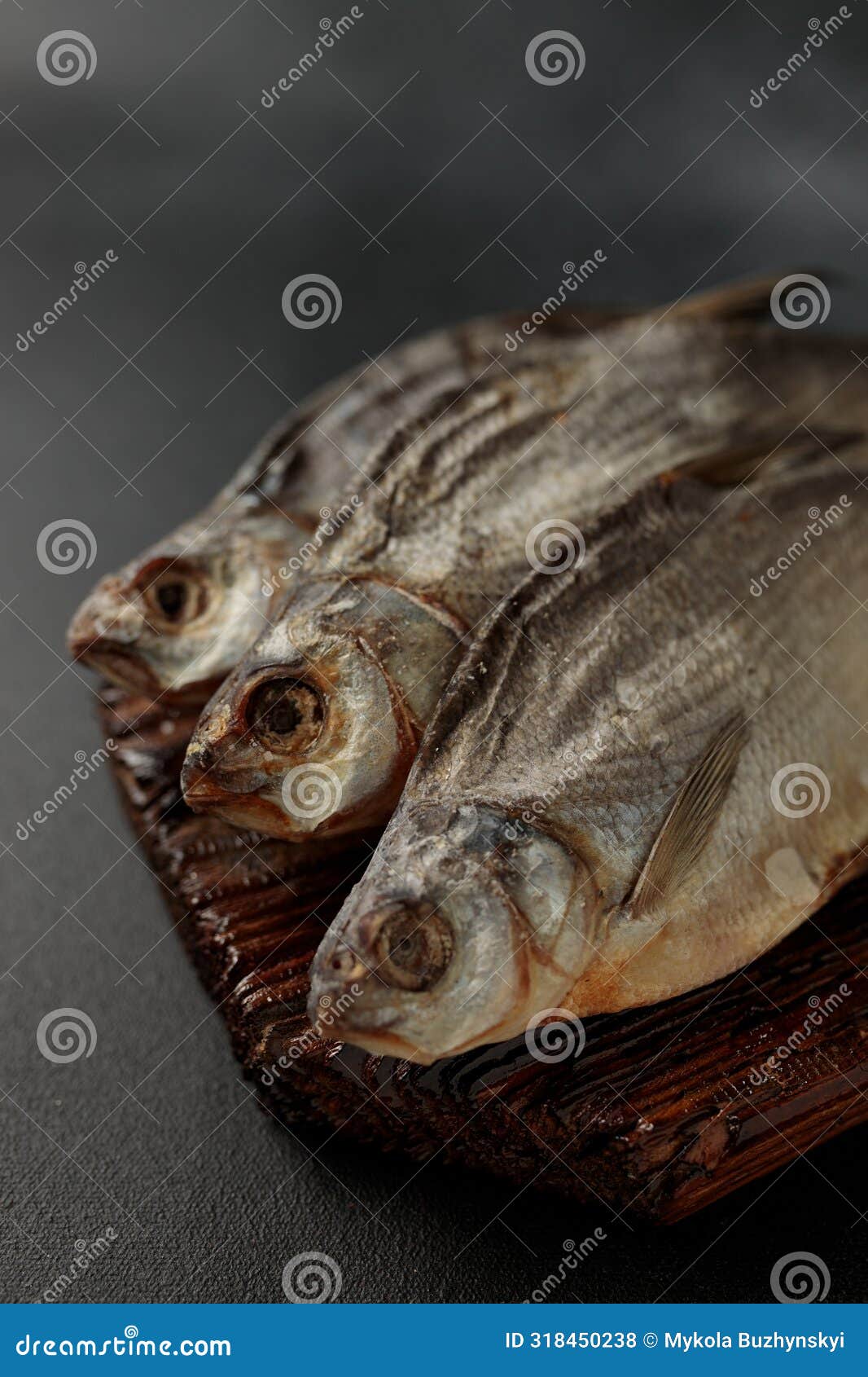 Dried Bream Fish on a Cutting Board on a Black Background Stock Photo ...