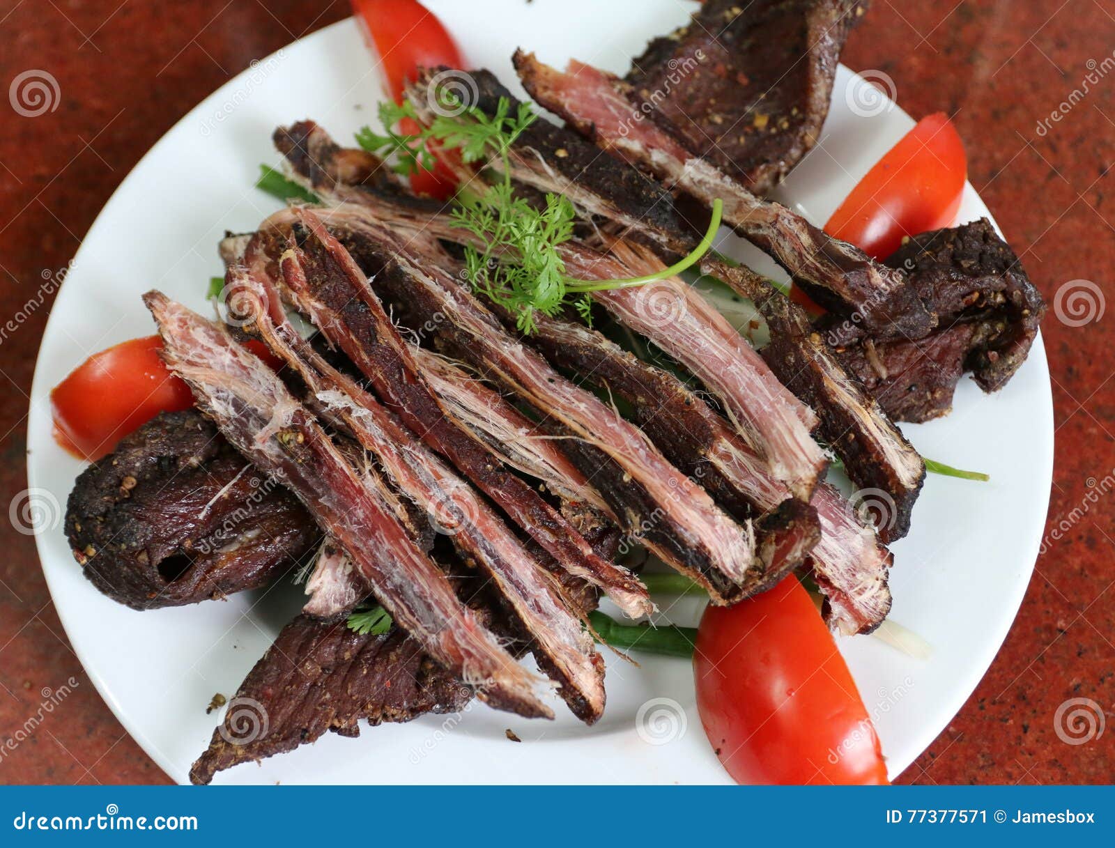 Dried Buffalo Meat on White Dish with Tomato and Herbs Stock Image ...