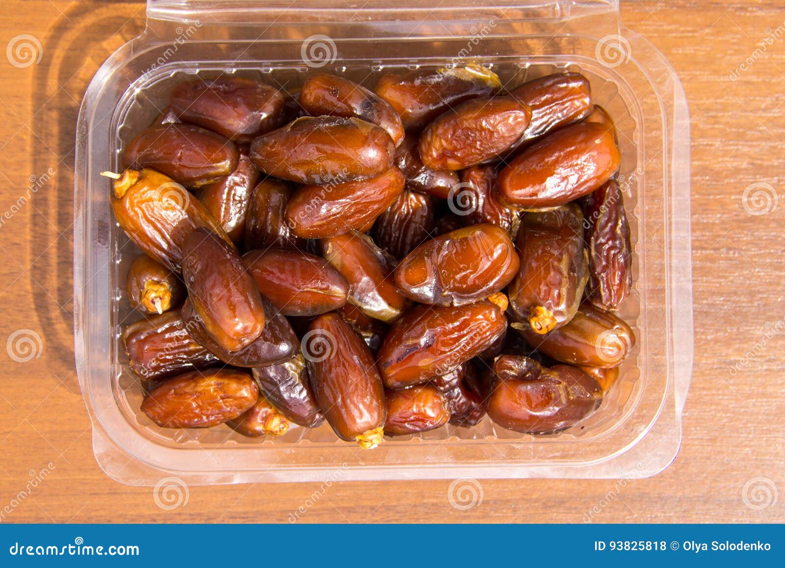 Dried Date Fruits in Plastic Container on Wooden Table Stock Photo ...