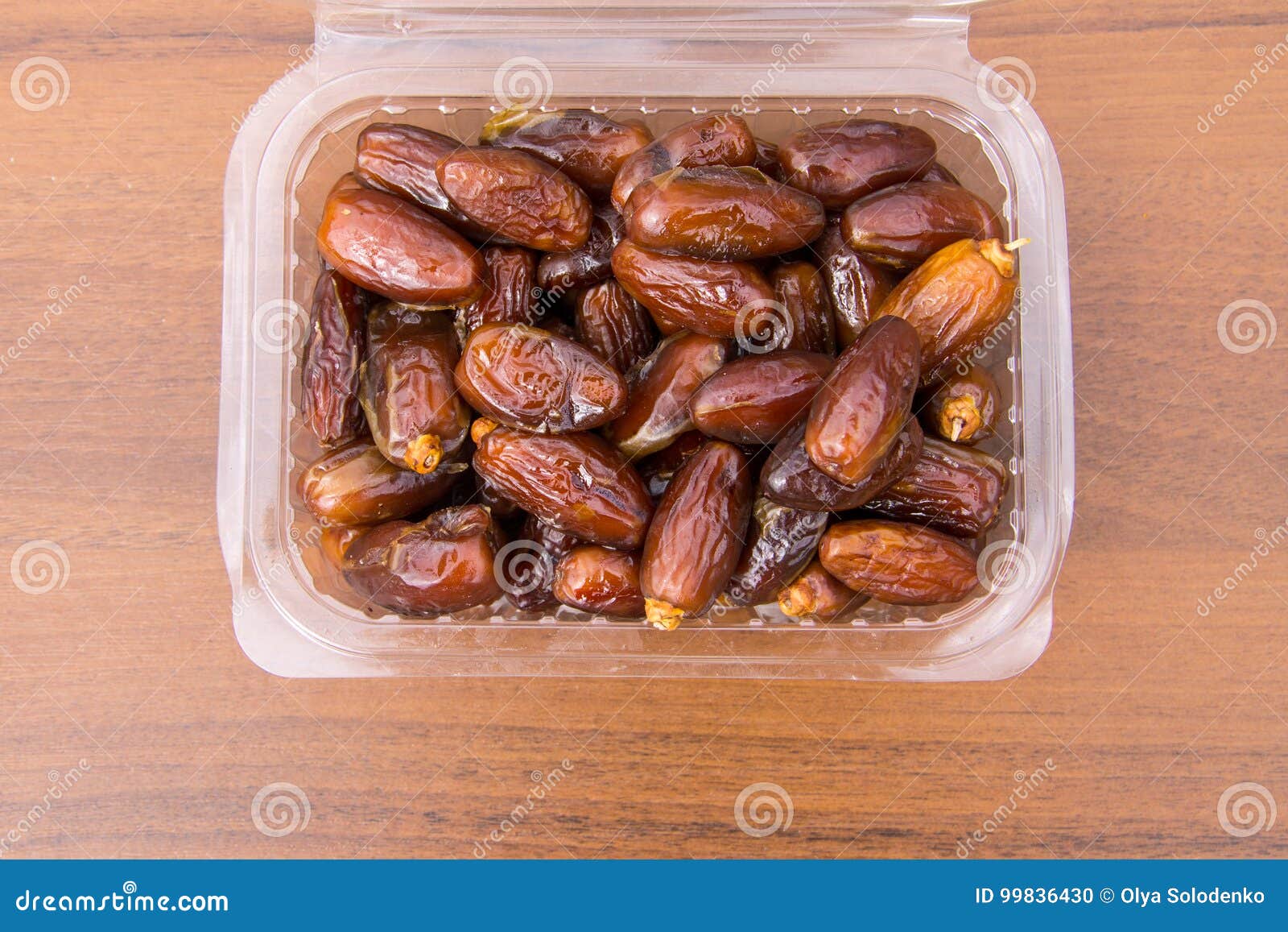 Dried Date Fruits in Plastic Container on Wooden Table Stock Photo ...
