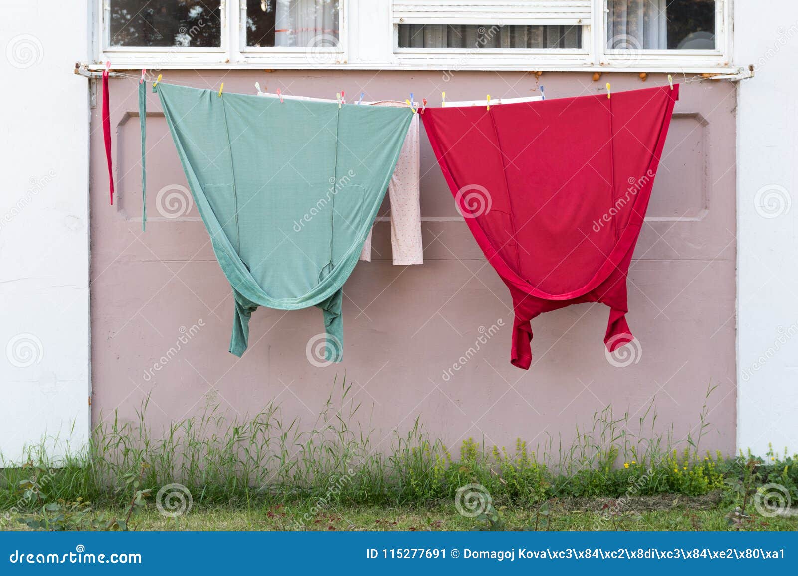 Dried Laundry Hanging on Line. Red and Green Clothes Stock Image ...