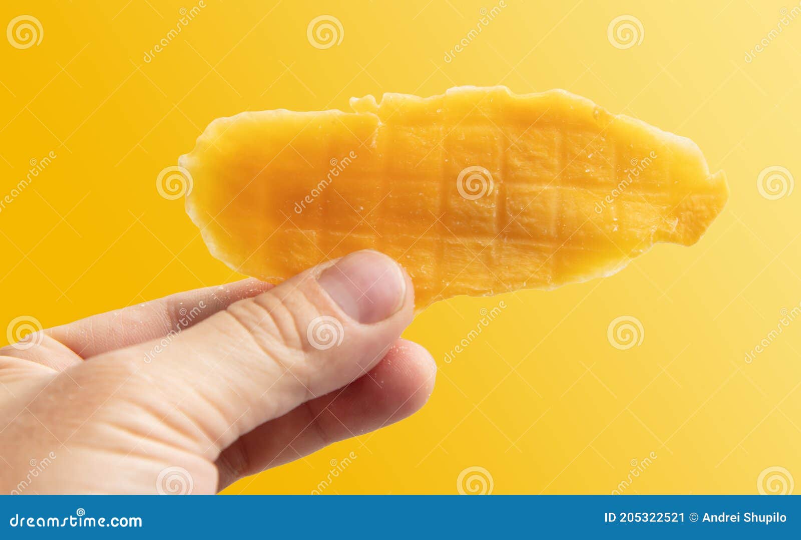 Dried Mango in Hand Isolated on Yellow Background Stock Image - Image ...