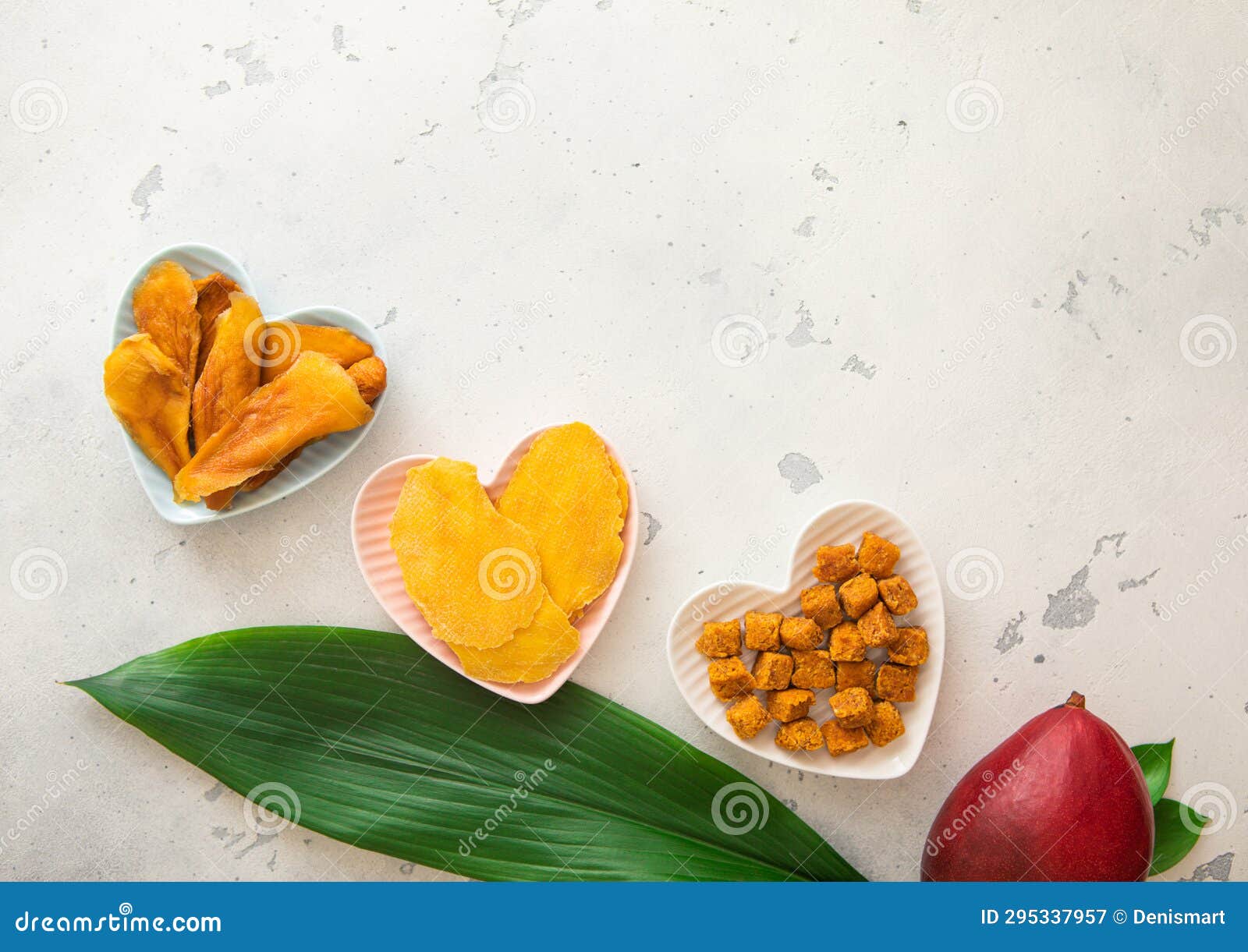 Dried Mango Slices and Balls in Heart Shaped Plates on Light Board ...