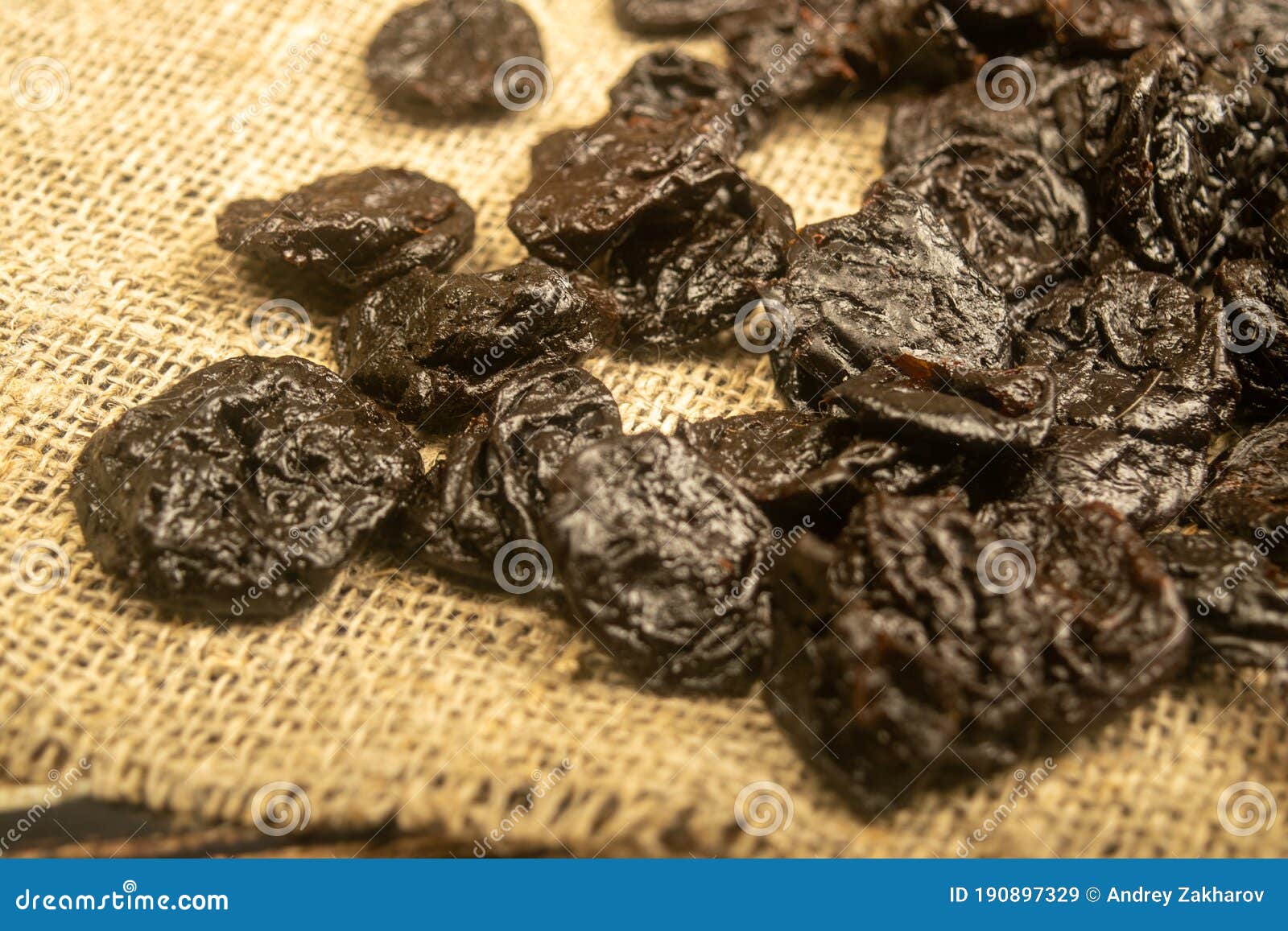 Dried Prunes in Bulk on Burlap with a Rough Texture. Close Up Stock ... Dried Prunes in Bulk on Burlap with a Rough Texture. Close Up Stock ...