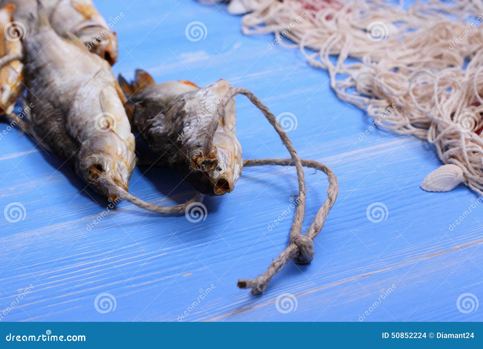Dried Rudd Fish and Fishing Net on Blue Background Stock Photo - Image ...