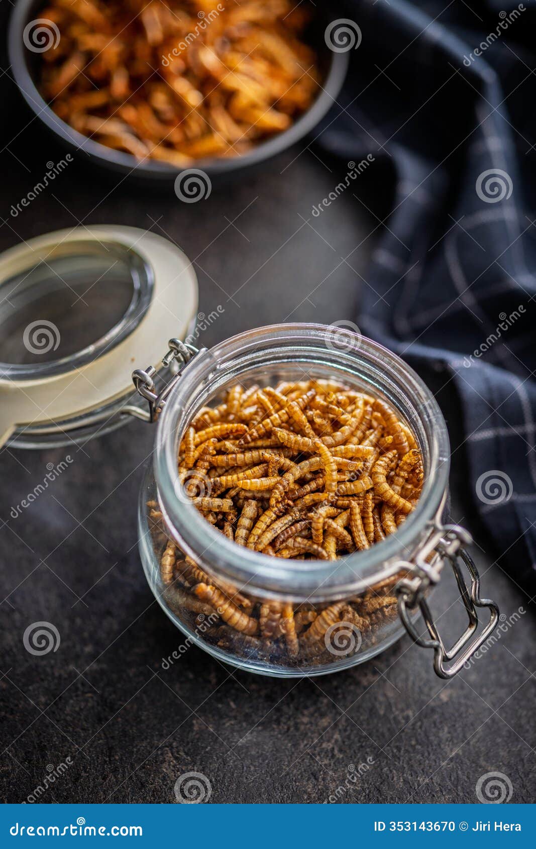 Dried Salted Worms. Roasted Mealworms in Jar on Black Table Stock Photo ...