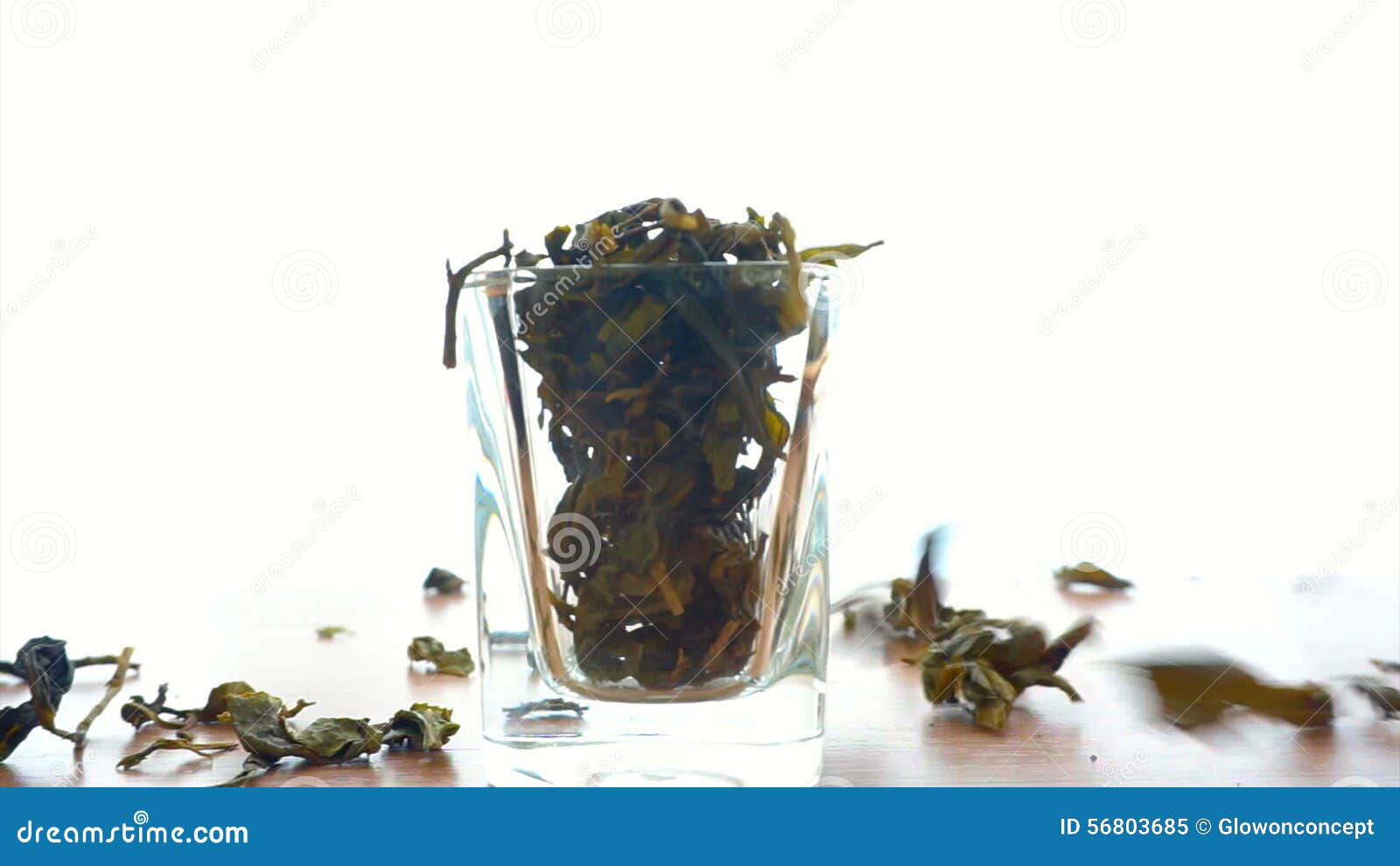 Dried Tea Leaf Filling Clear Glass on White Background Stock Video ...