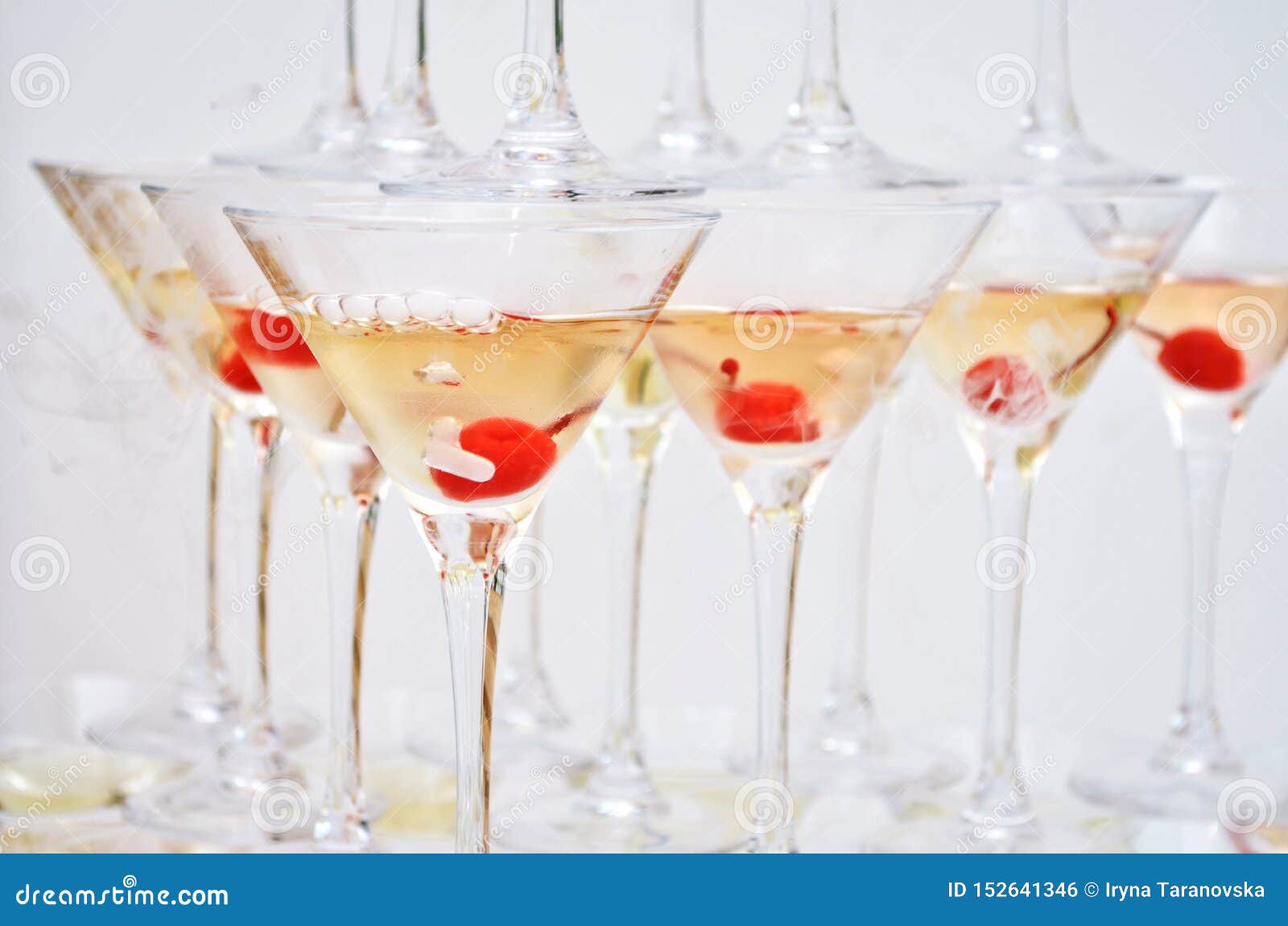 Driehoekige Die Martini-glazen, Met Champagne Met Kersen En Vloeibare ... Driehoekige Die Martini-glazen, Met Champagne Met Kersen En Vloeibare ...
