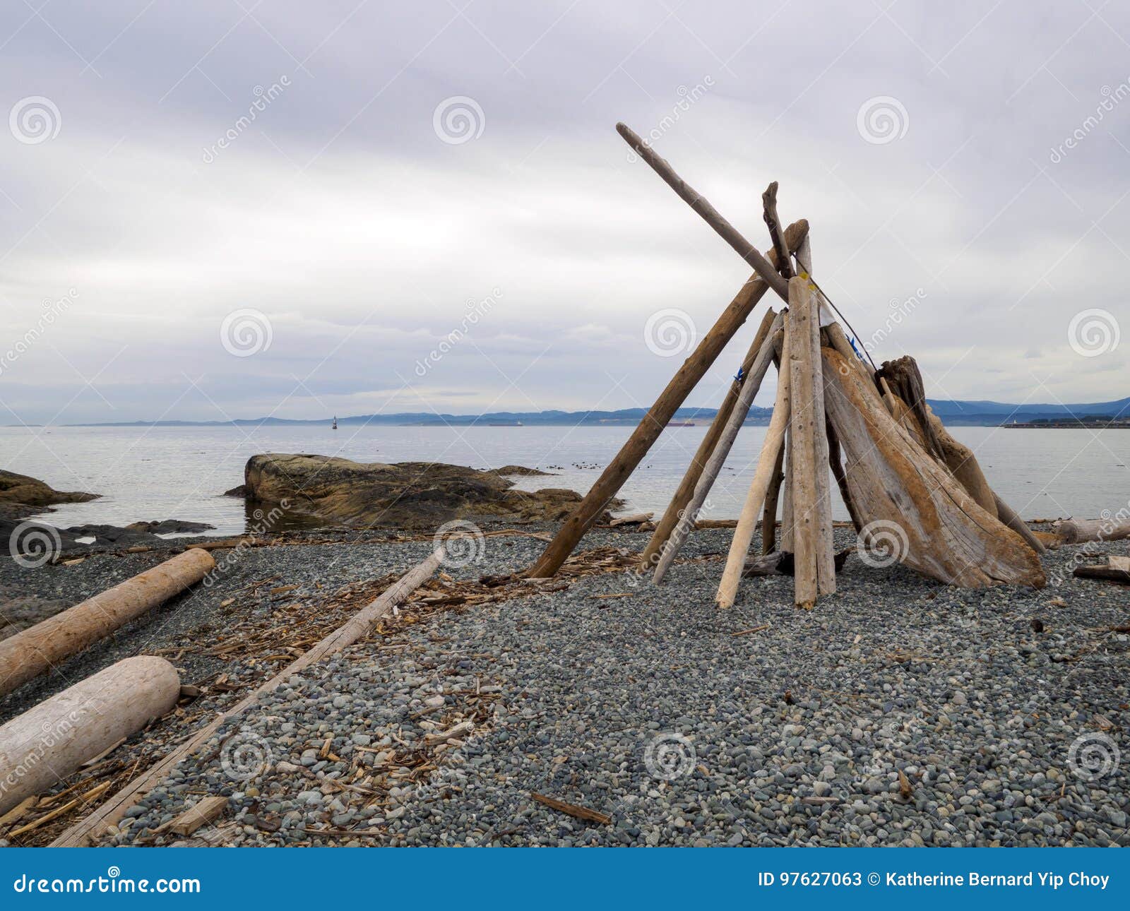 Driftwood Teepee Tipi Structure on a Rock Pebble Beach by the Water on ...