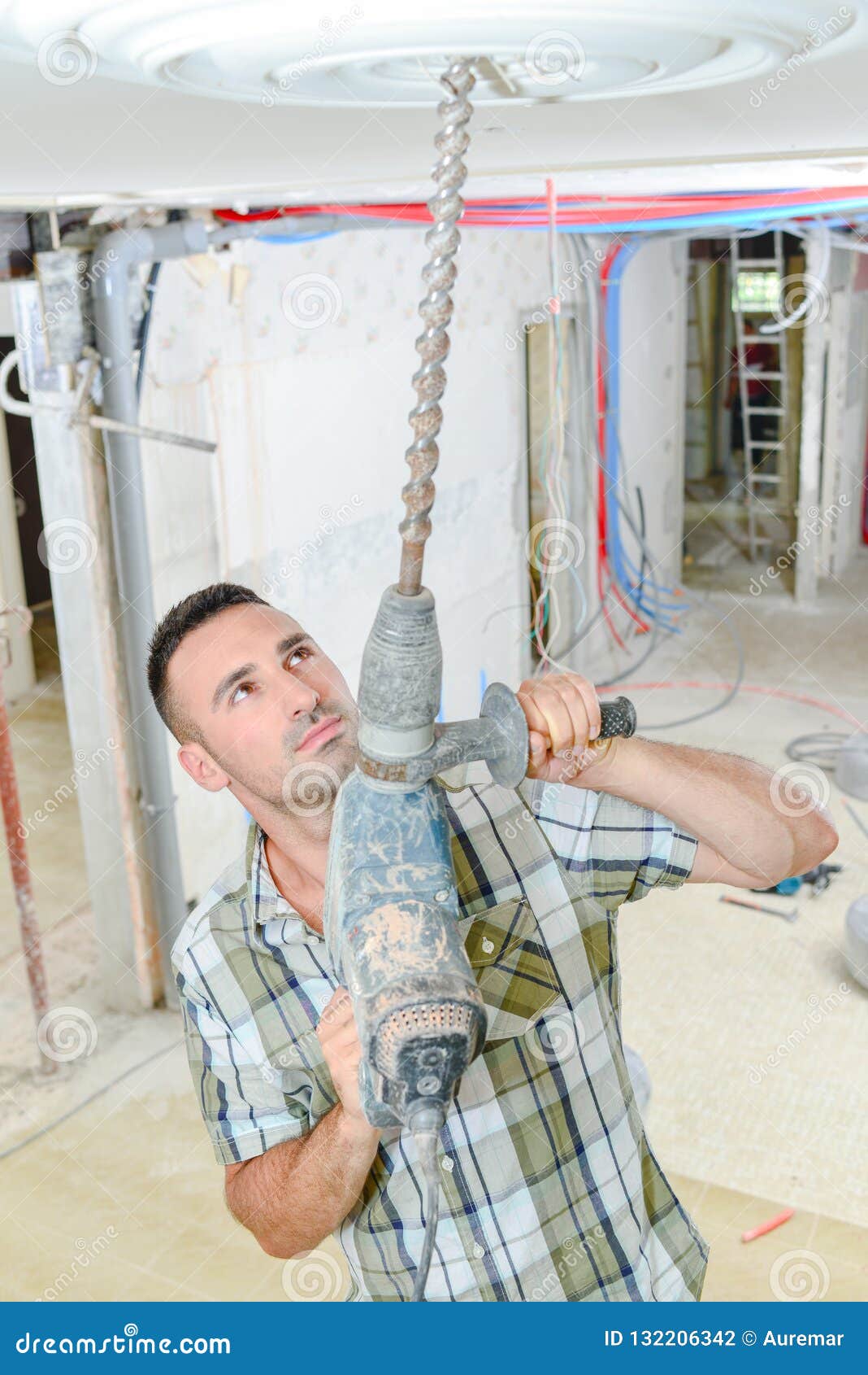Drilling into the ceiling stock photo. Image of people - 132206342