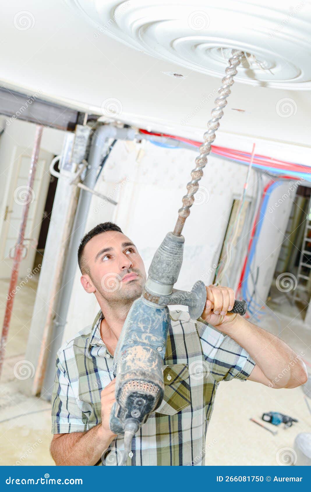 Drilling into the ceiling stock photo. Image of installation - 266081750
