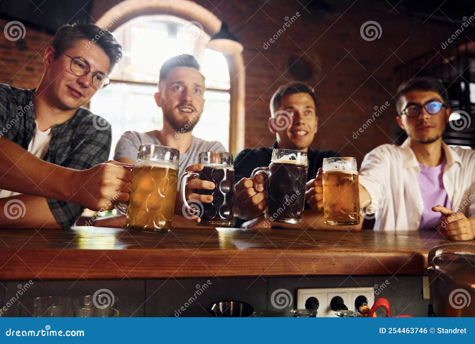 Drinking Beer. People in Casual Clothes Sitting in the Pub Stock Photo ...