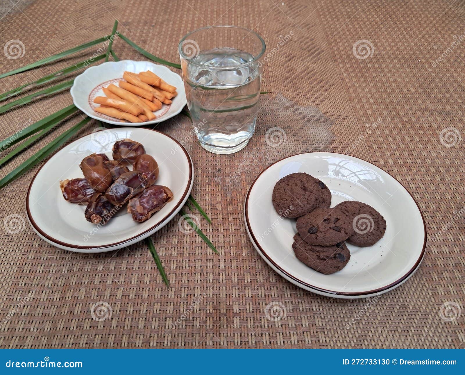 Drinking Water, Dates, Cheese Stick and Chocolate Biscuit Stock Photo ...