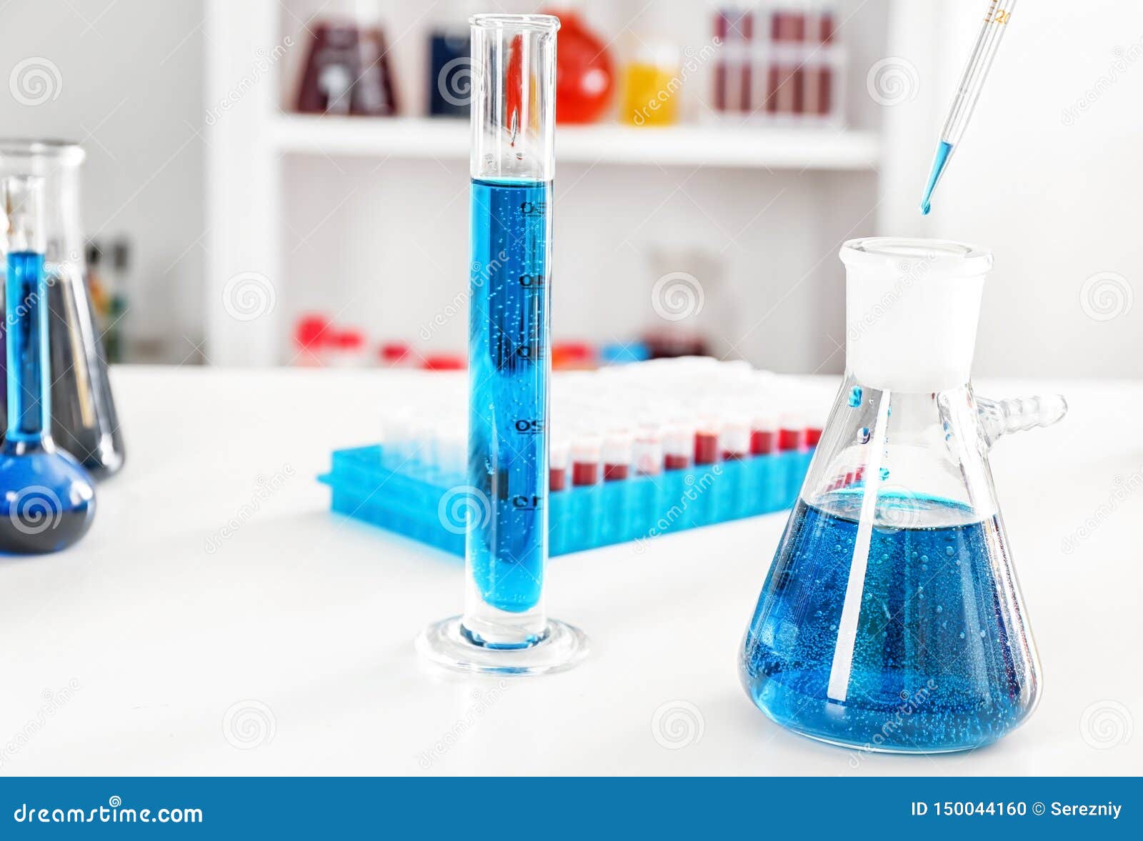 Dripping Blue Liquid into Flask on Table Stock Photo - Image of ...