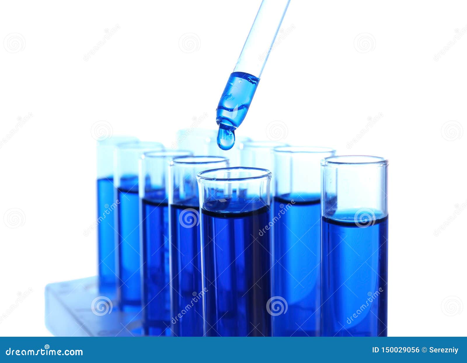 Dripping Blue Liquid into Test Tubes on White Background Stock Photo ...
