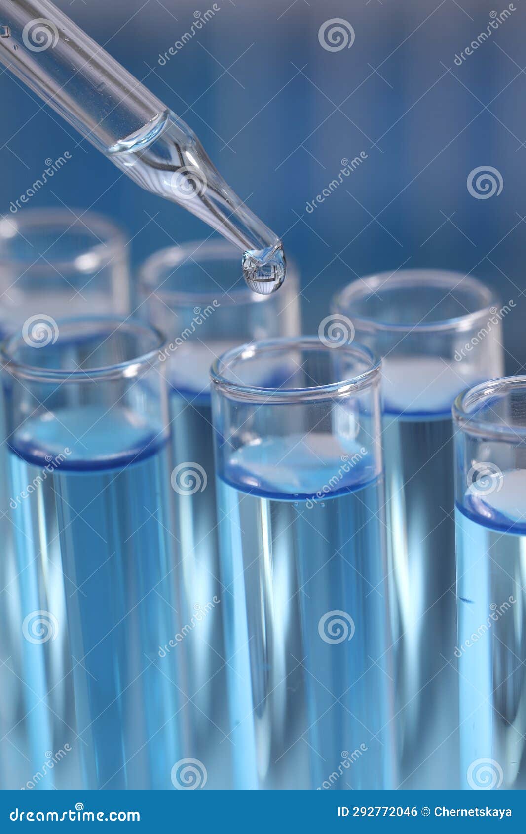 Dripping Reagent into Test Tube on Blurred Background, Closeup ...