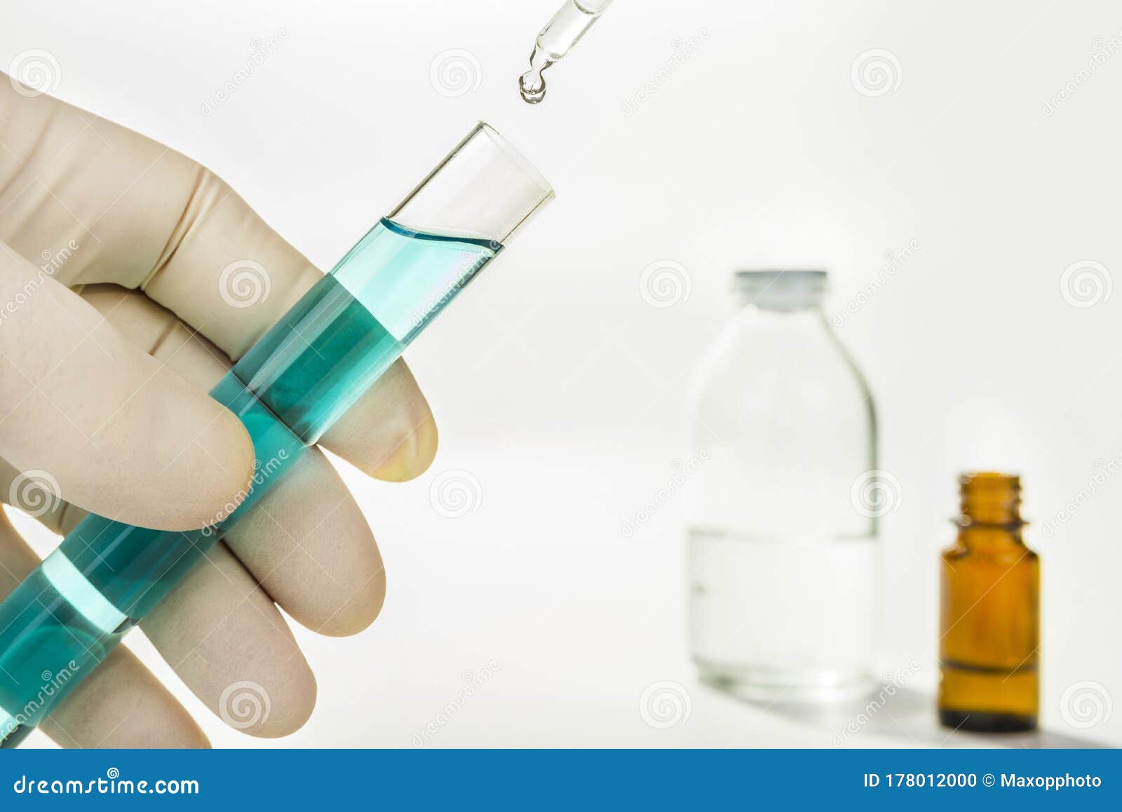 Dripping Reagent into Test Tube with Liquid Sample Stock Photo - Image ...