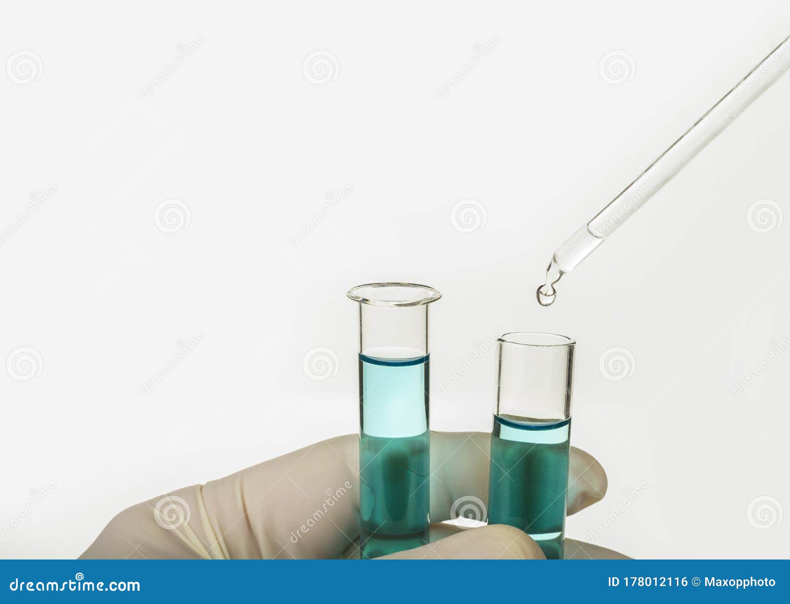 Dripping Reagent Into Test Tube With Liquid Sample On Background ...