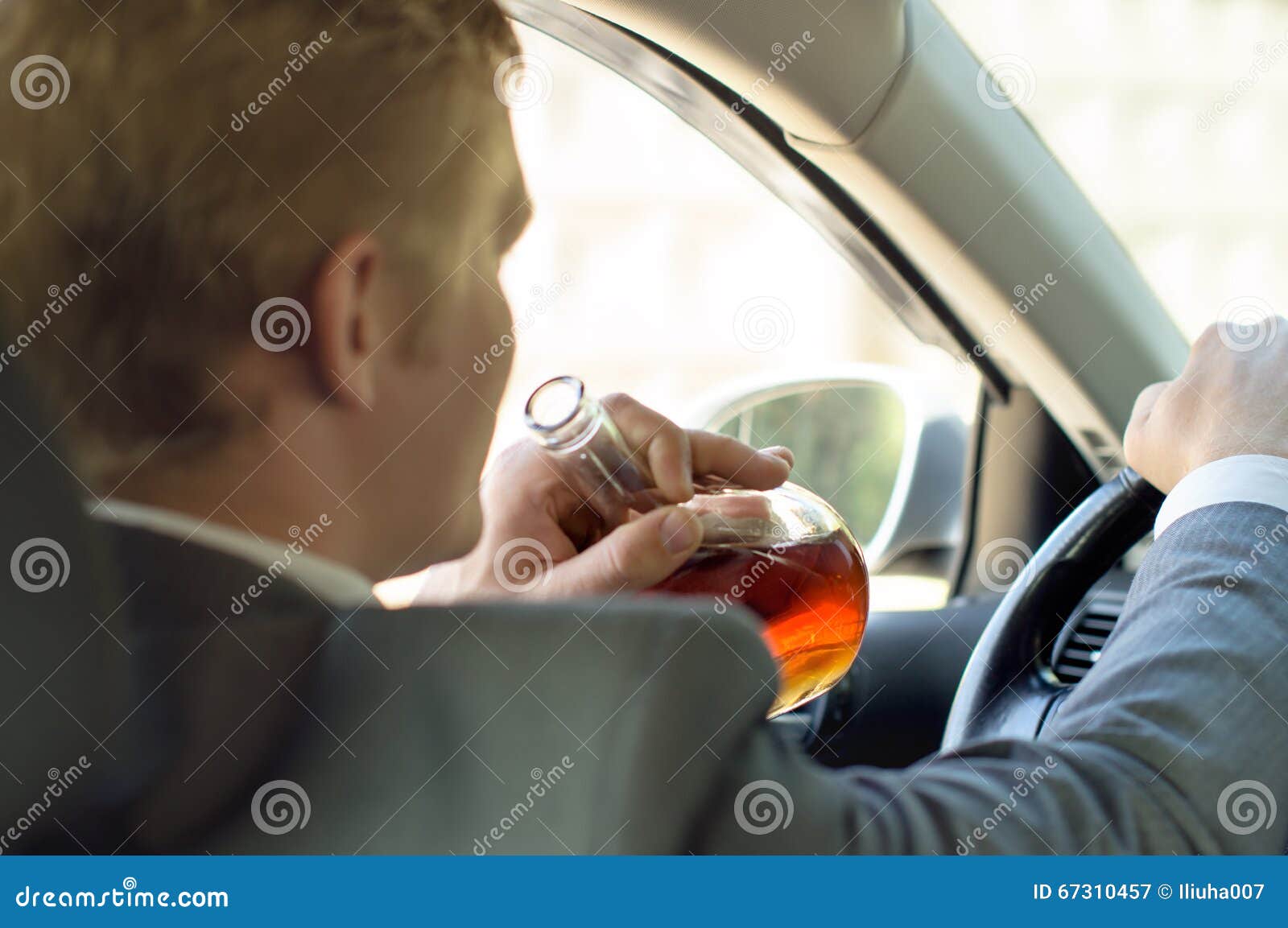 Driver With A Bottle Of Alcohol At The Wheel Stock Image Image Of