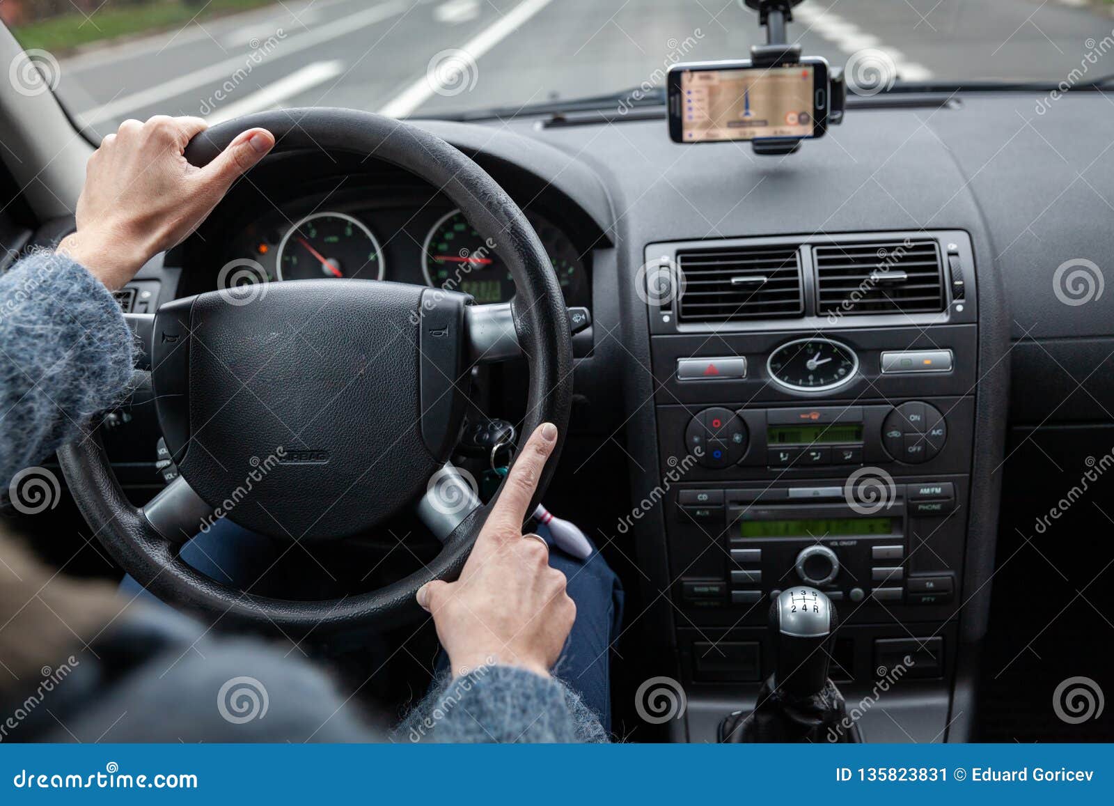 A Driver in a Car Performs Tasks Necessary To Steer the Vehicle Stock ...