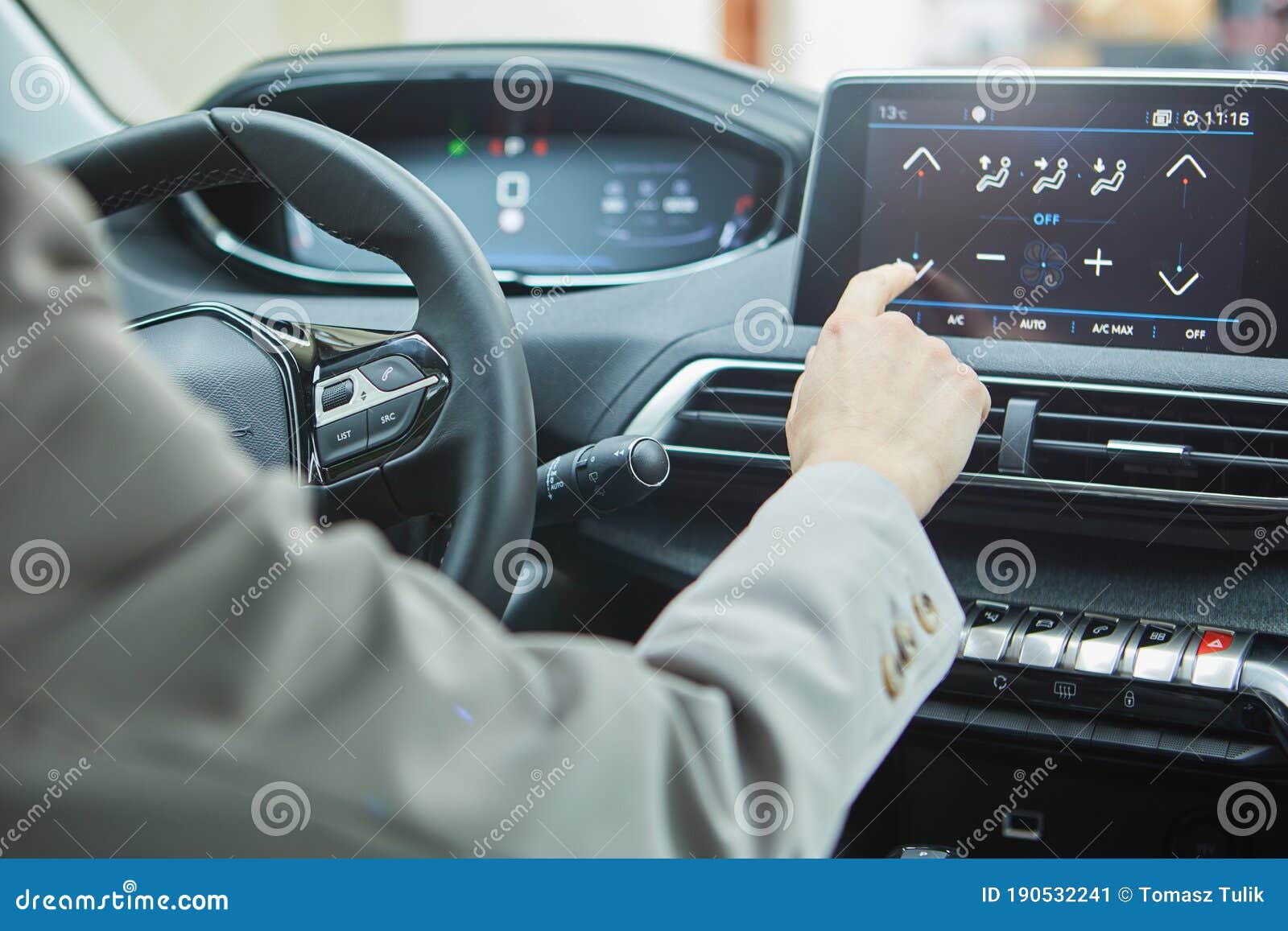 The Driver Controls the Air Conditioning in a Modern Electric Car Stock ...