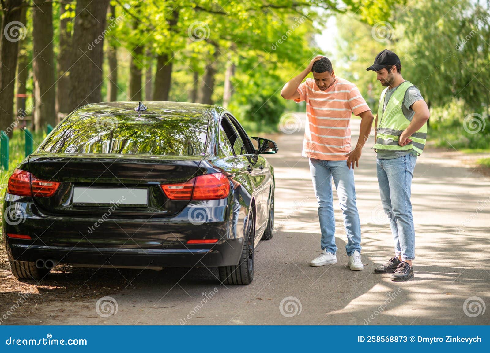 A Driver Discussing a Car Accident with a Service Man and Looking ...